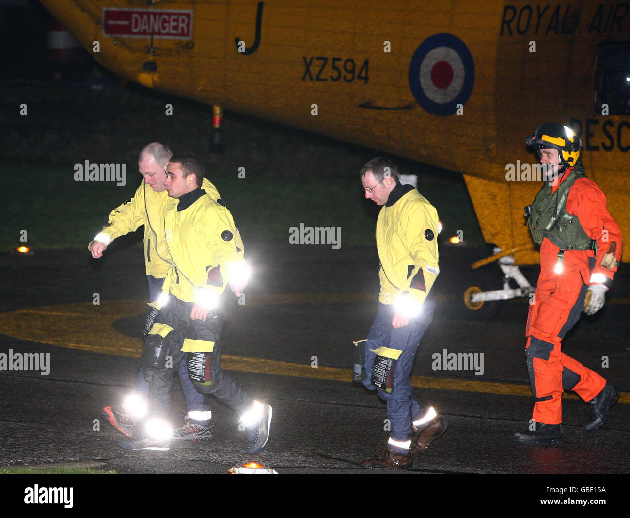 Rescued crew from the ditched helicopter arrive at the helipad at the ...