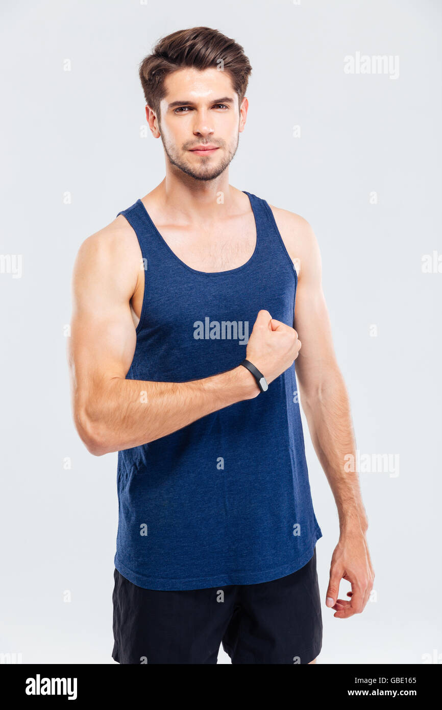 Close-up portrait of a concentrated man showing his biceps isolated on ...