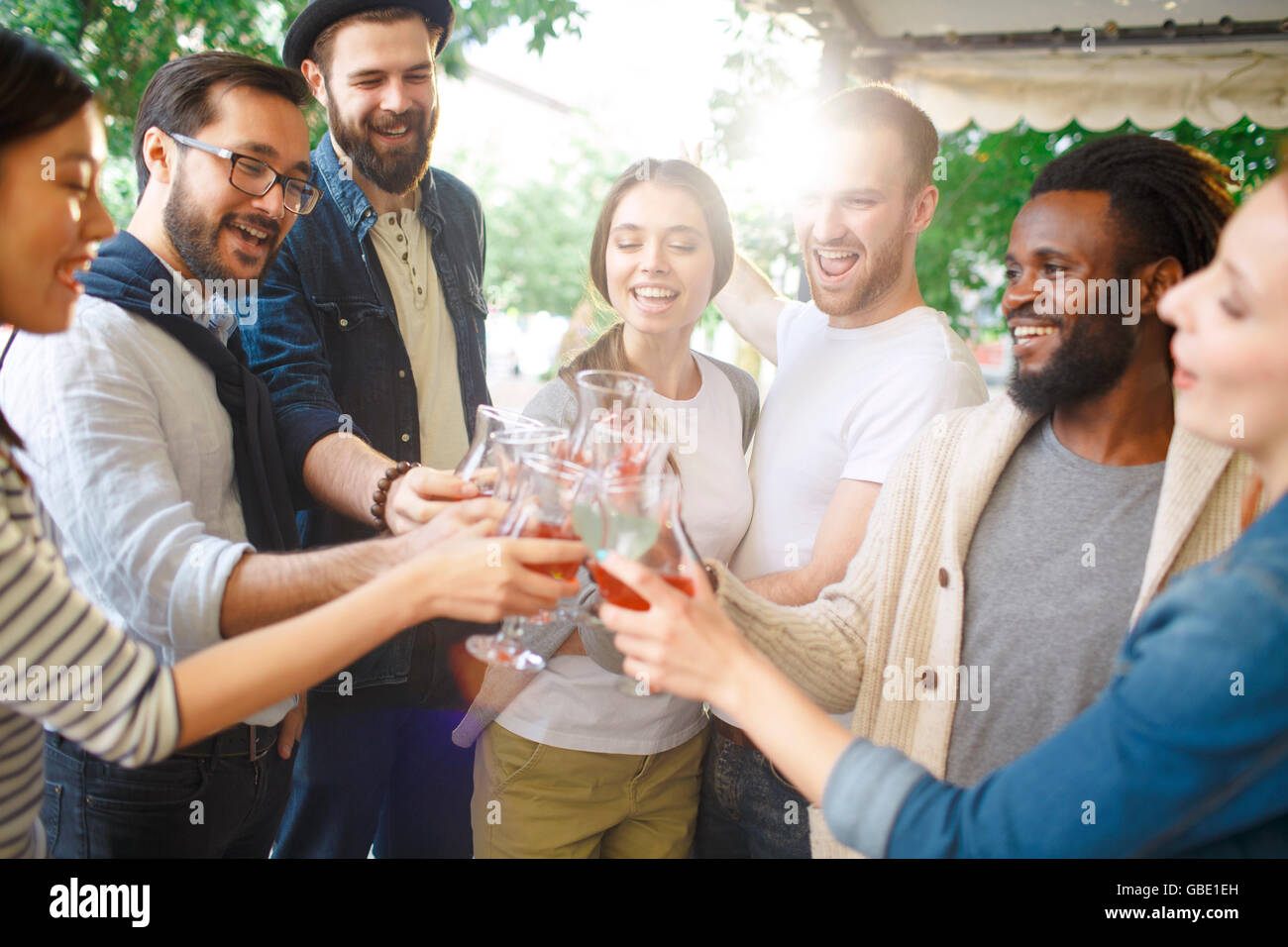 Handsome smiling friends cheering hi-res stock photography and images ...