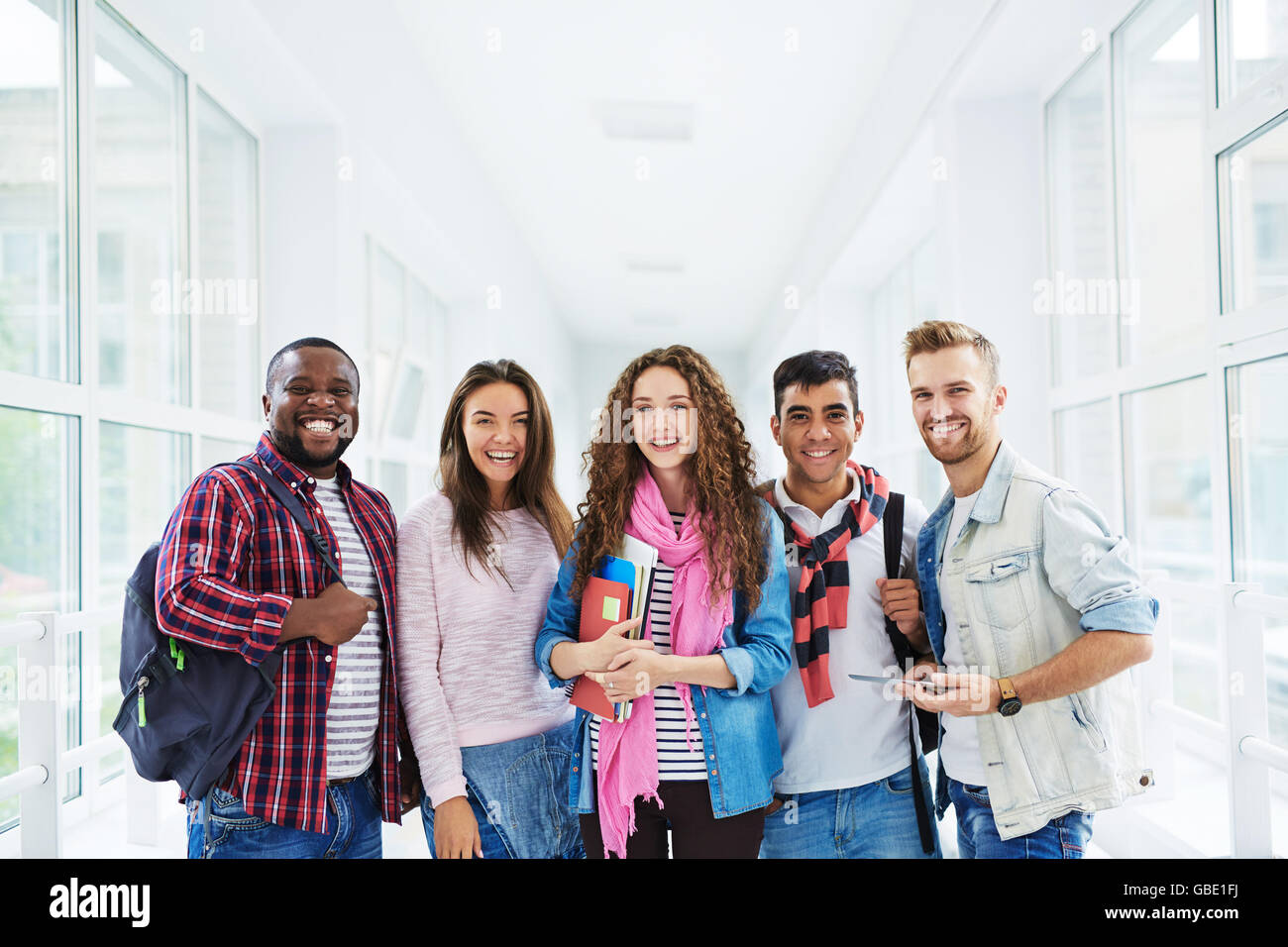 Cheerful students looking a camera with smiles Stock Photo - Alamy