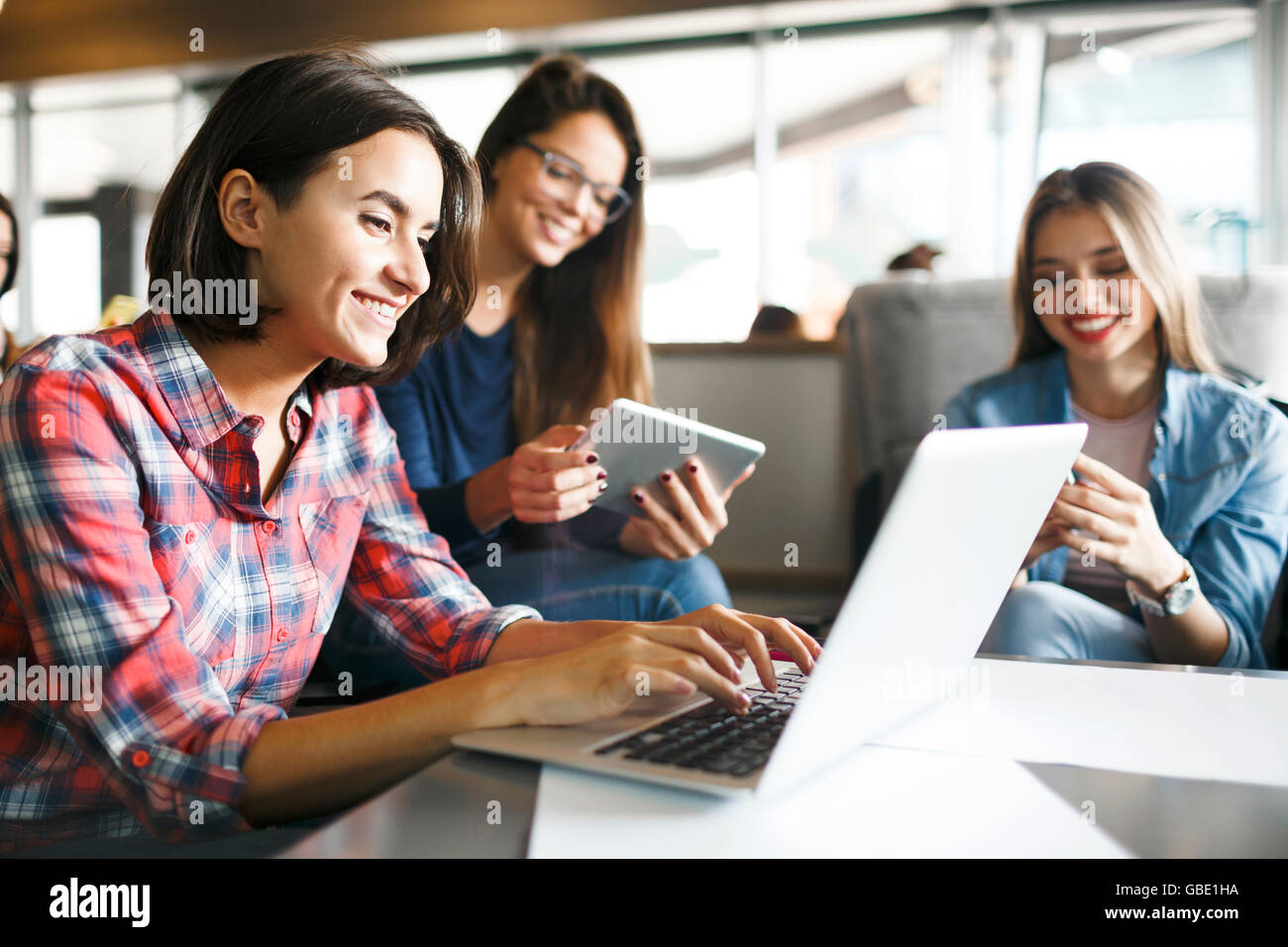 Cute students working with modern gadgets Stock Photo - Alamy