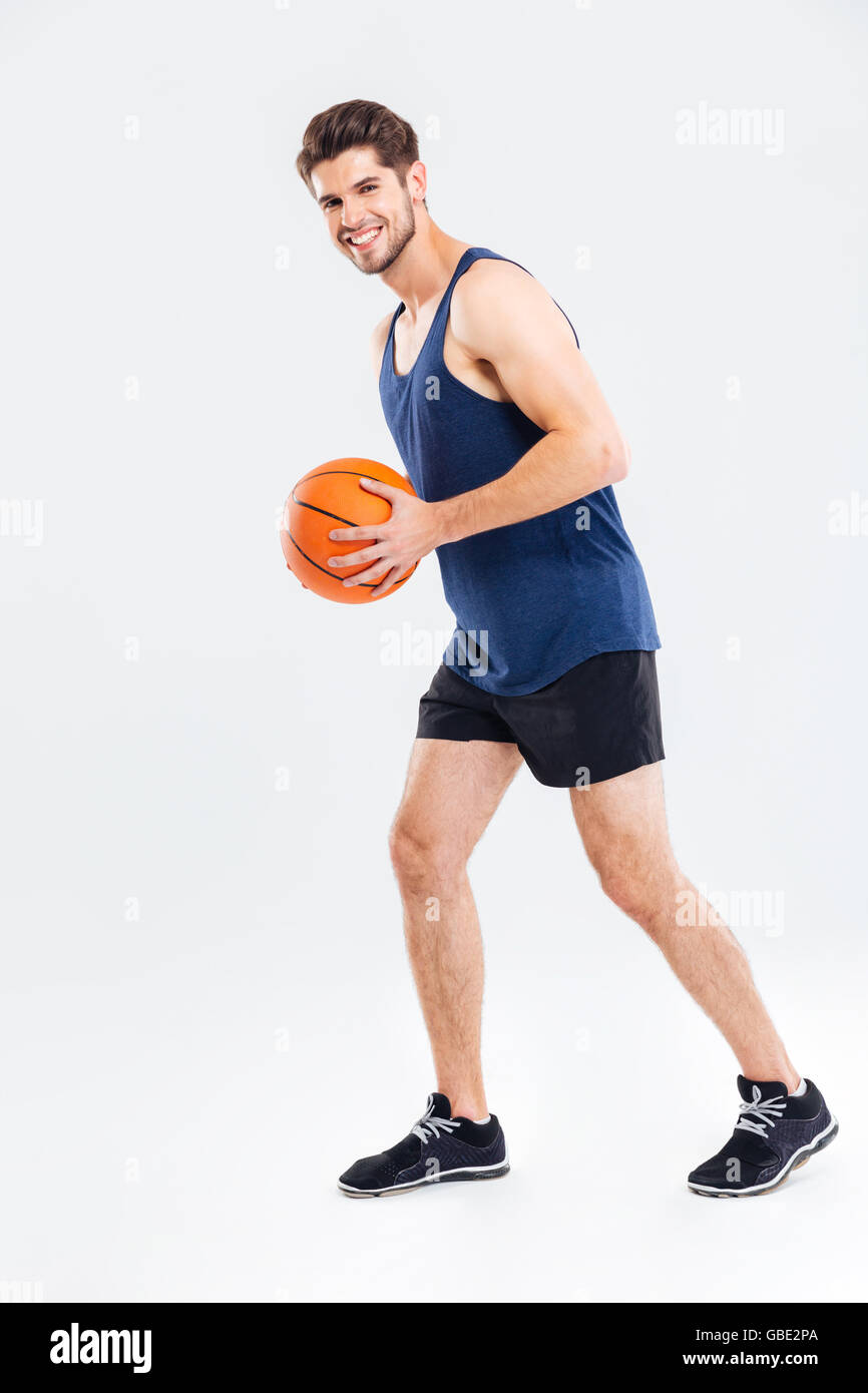 Happy young guy playing basketball hi-res stock photography and images ...