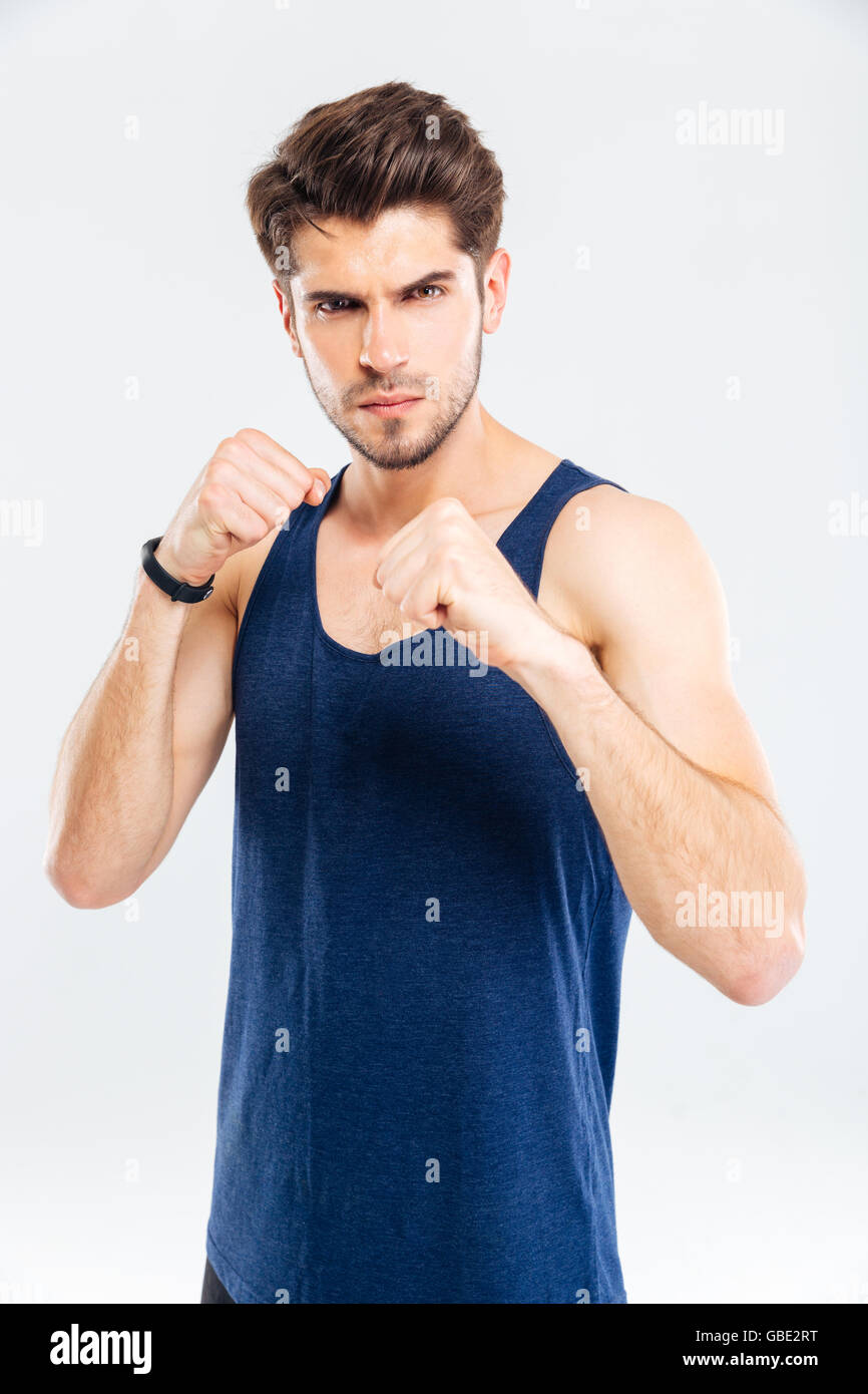 Portrait of a muscular male fighter standing over gray background Stock ...