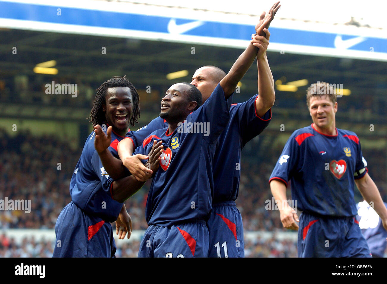 Portsmouth's Lomana Tresor LuaLua celebrates his goal with teammates ...