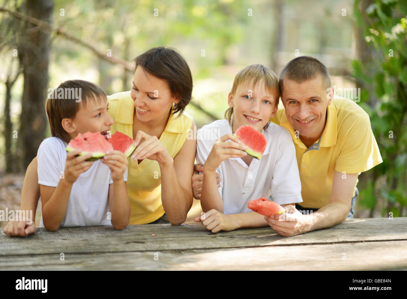 Happy family eating Stock Photo - Alamy