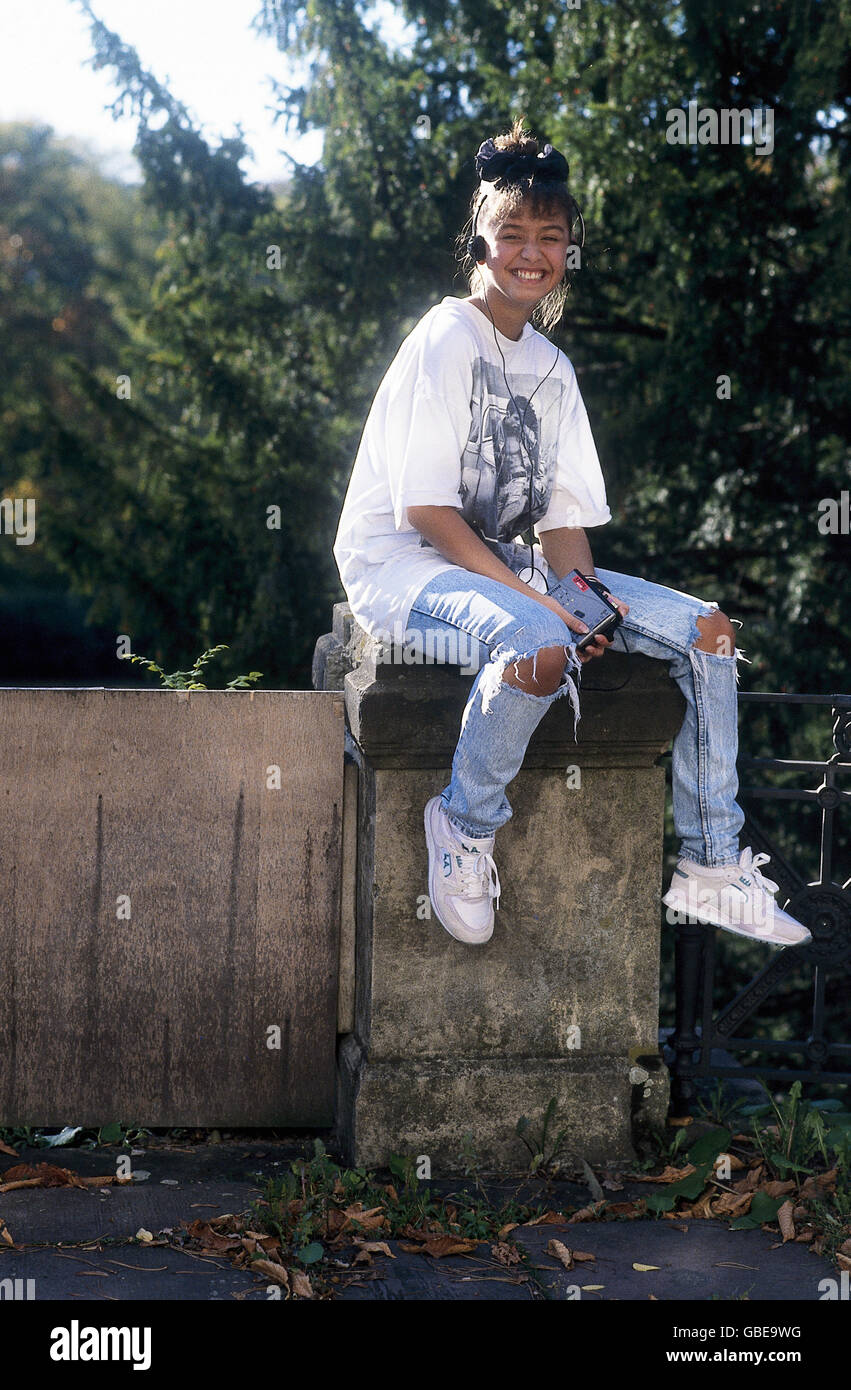people, teenager, 1980s, exterior, girl with walkman, sitting on wall ...