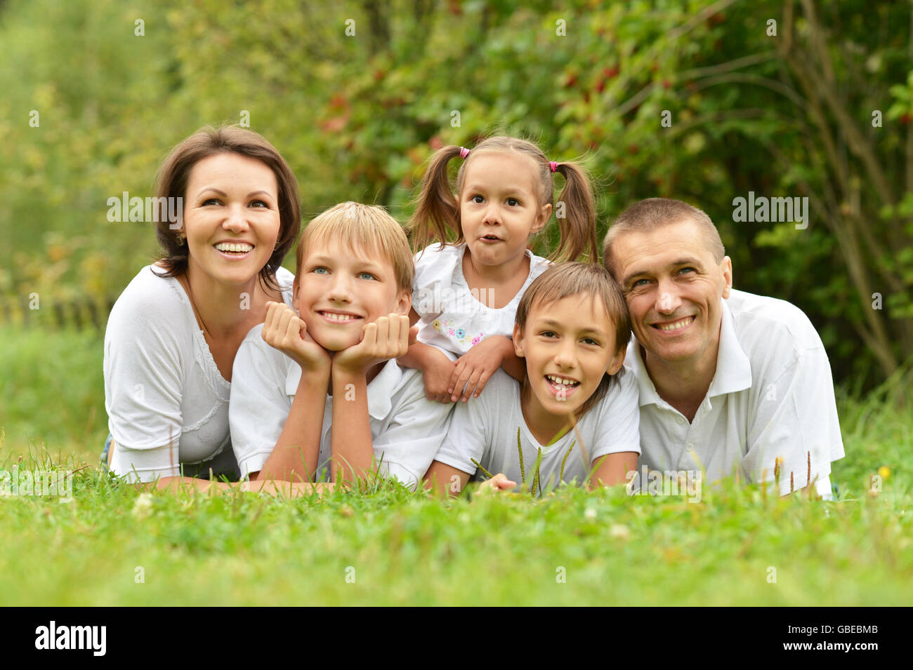 Family of five lying Stock Photo - Alamy