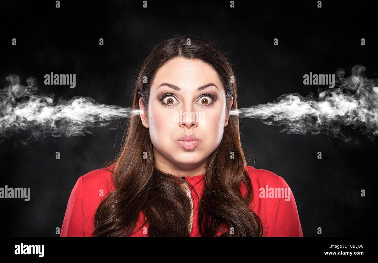 Smoke from the ears of a woman on a dark background. Overvoltage ...