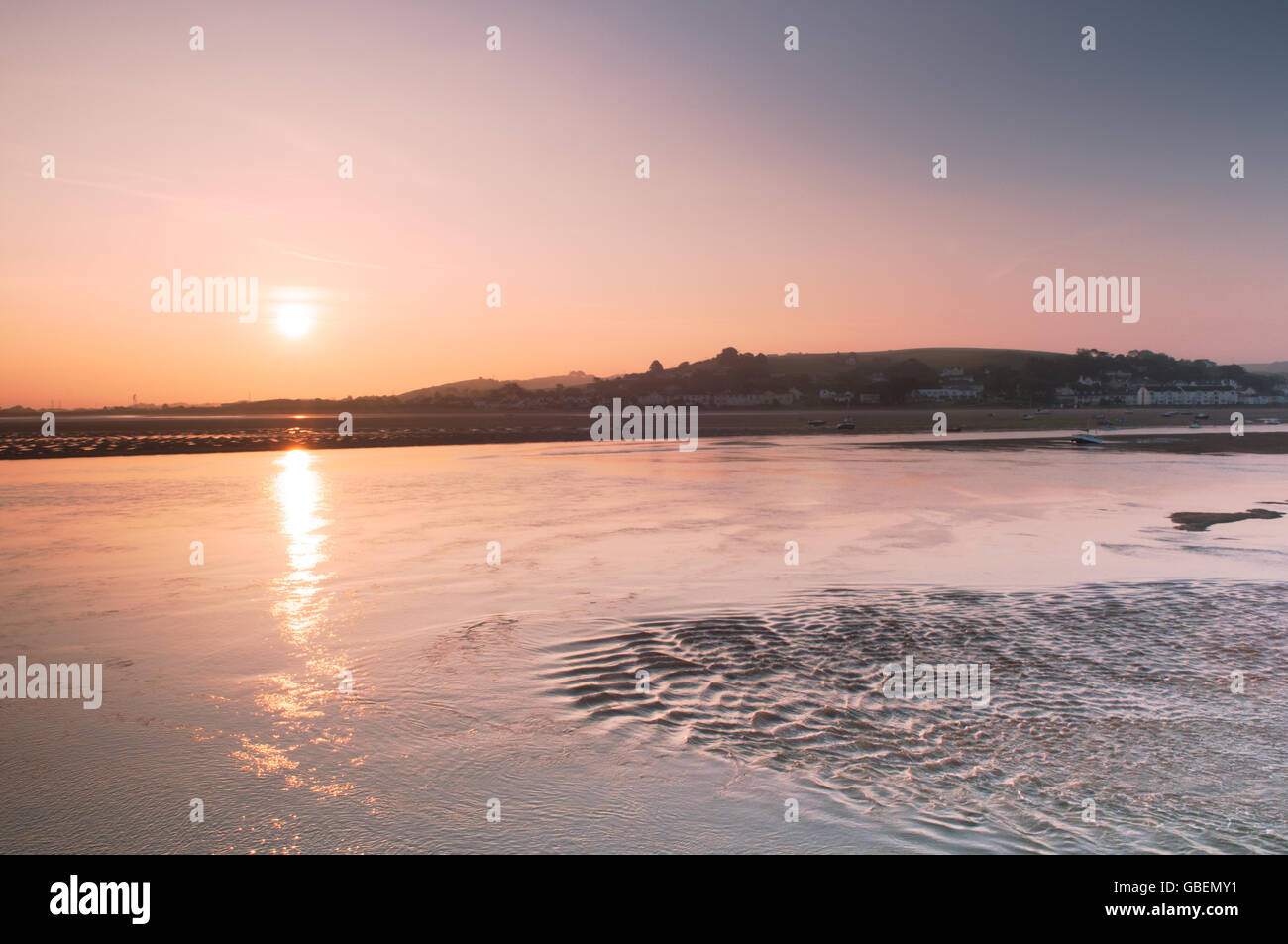 Sun rising over the water over the estuary leading to the ocean Stock ...