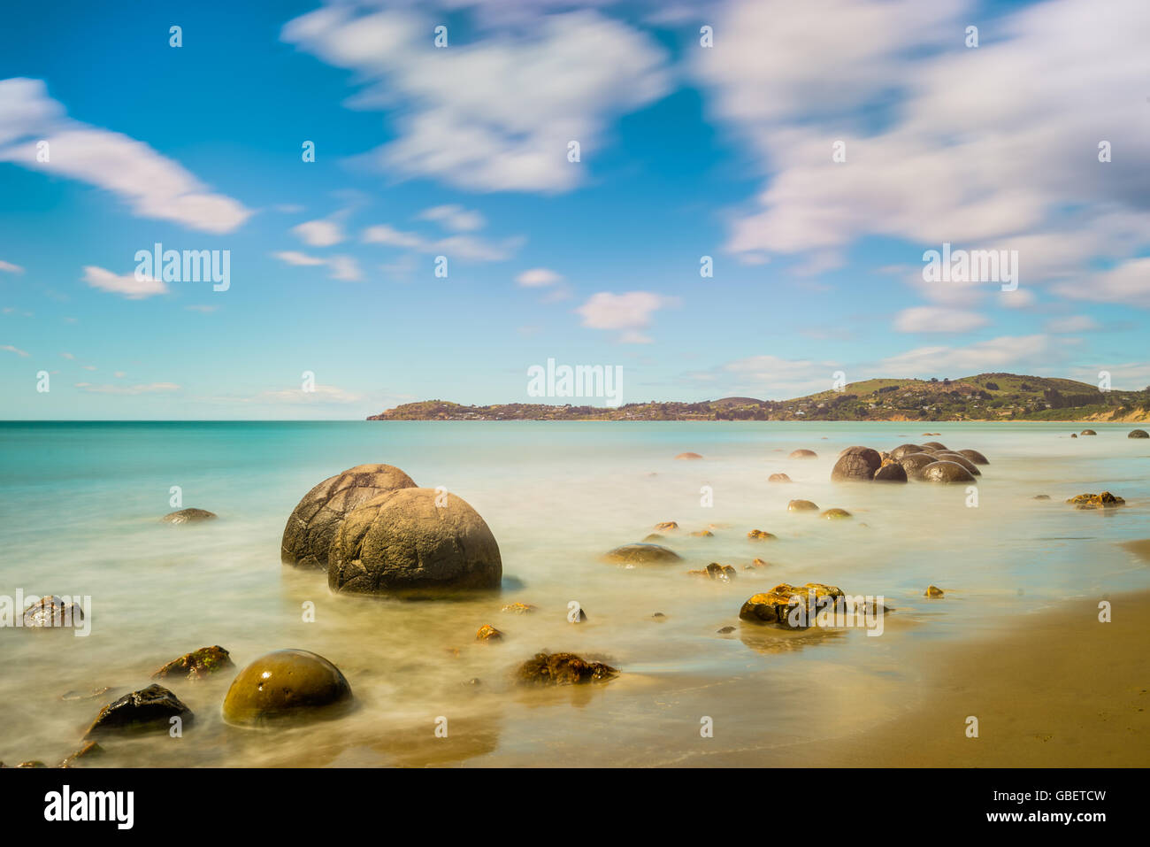 Long exposure image of Moeraki Boulders lying along a stretch of ...