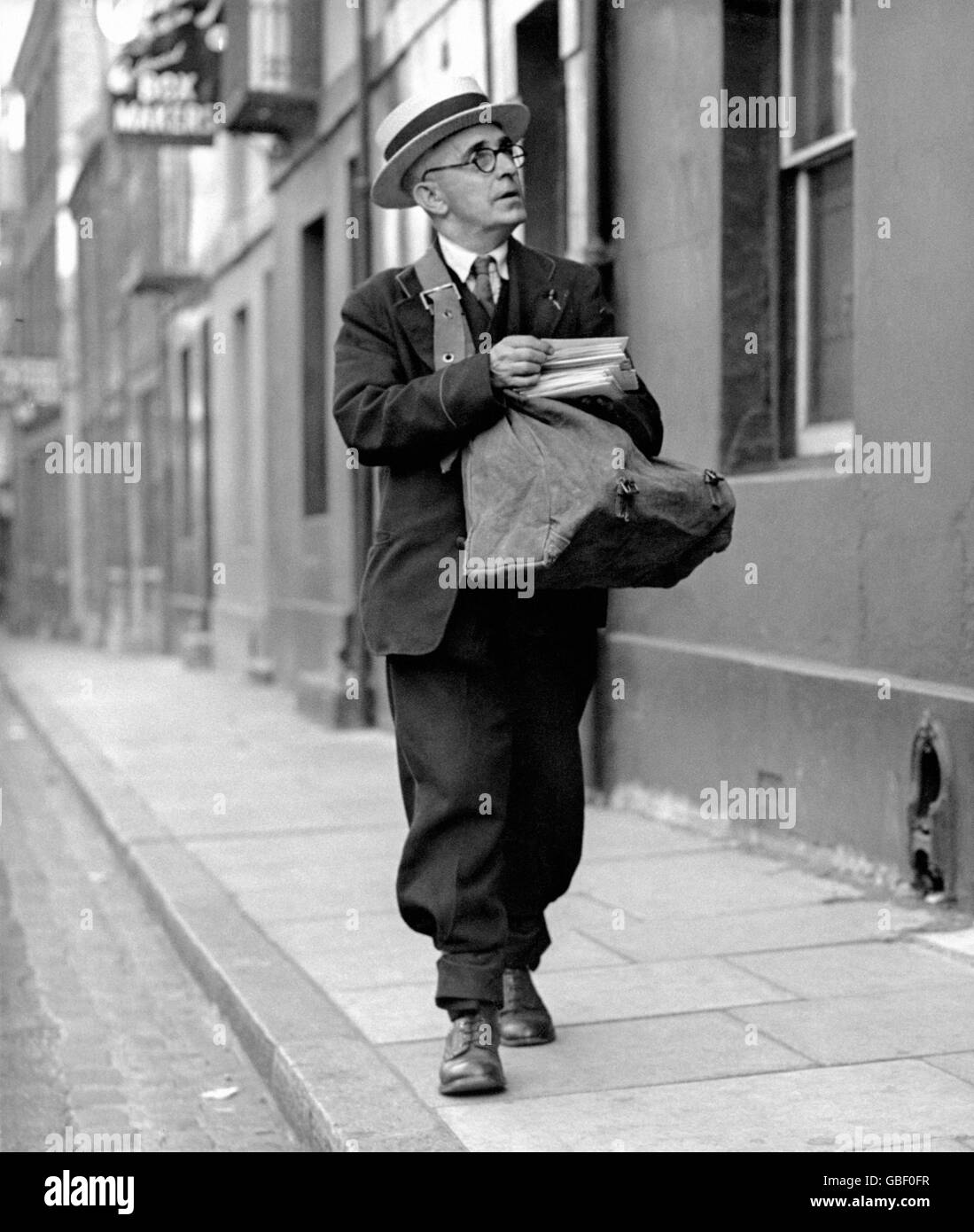 Postman Jack Pedley wearing a straw-boater on his rounds, to keep cool ...