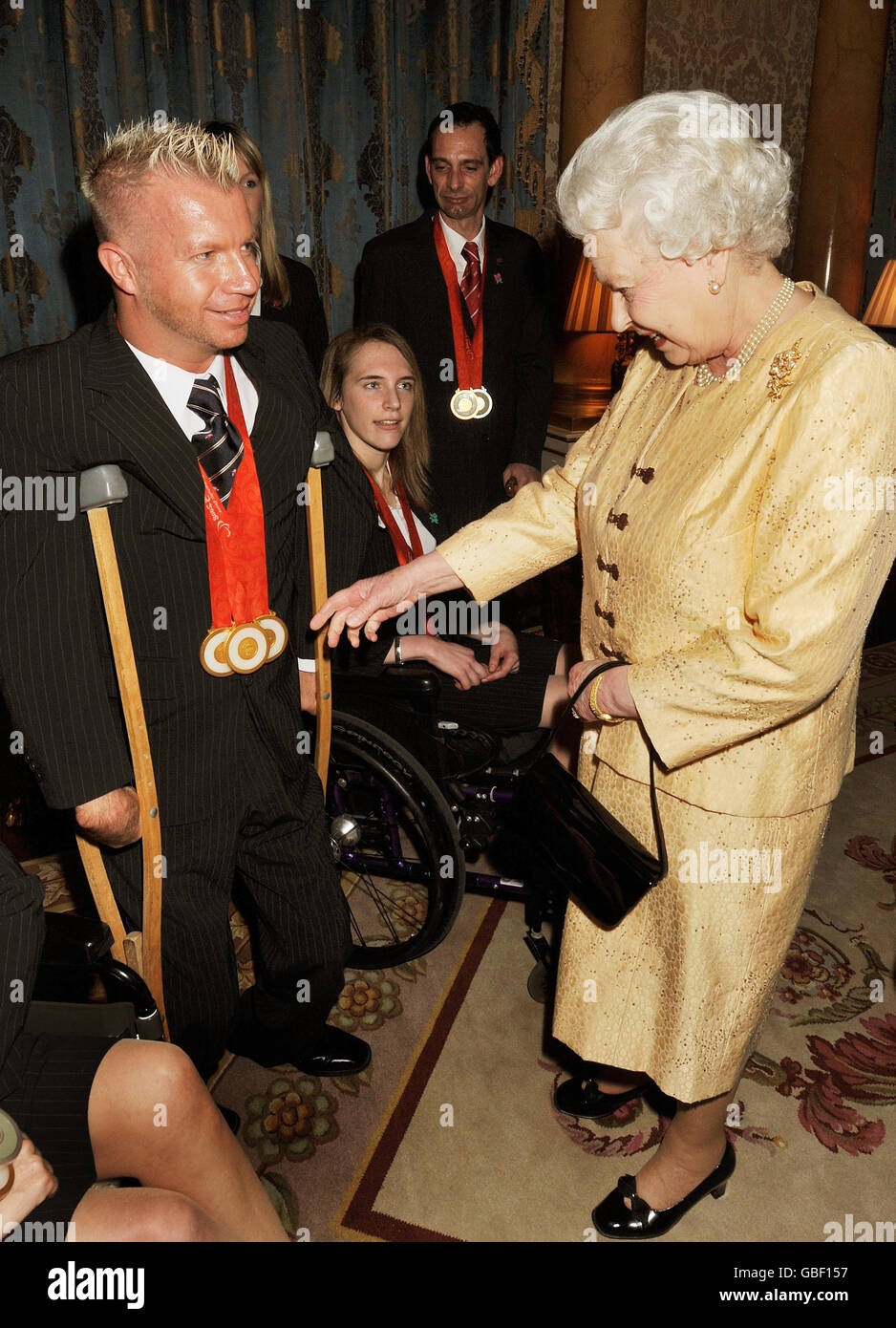 Britain's Queen Elizabeth II talking to triple gold medalist Lee ...