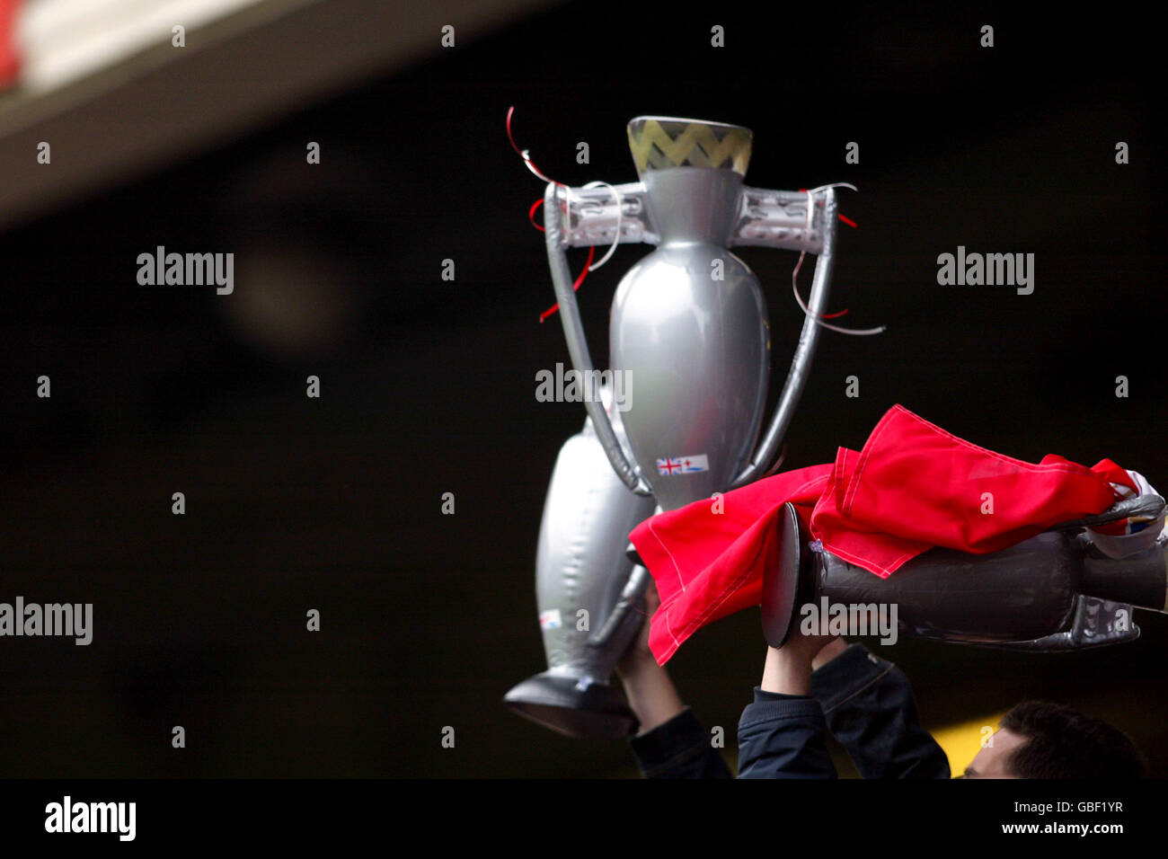 Arsenal fans wave inflatable trophies to celebrate their team winning ...