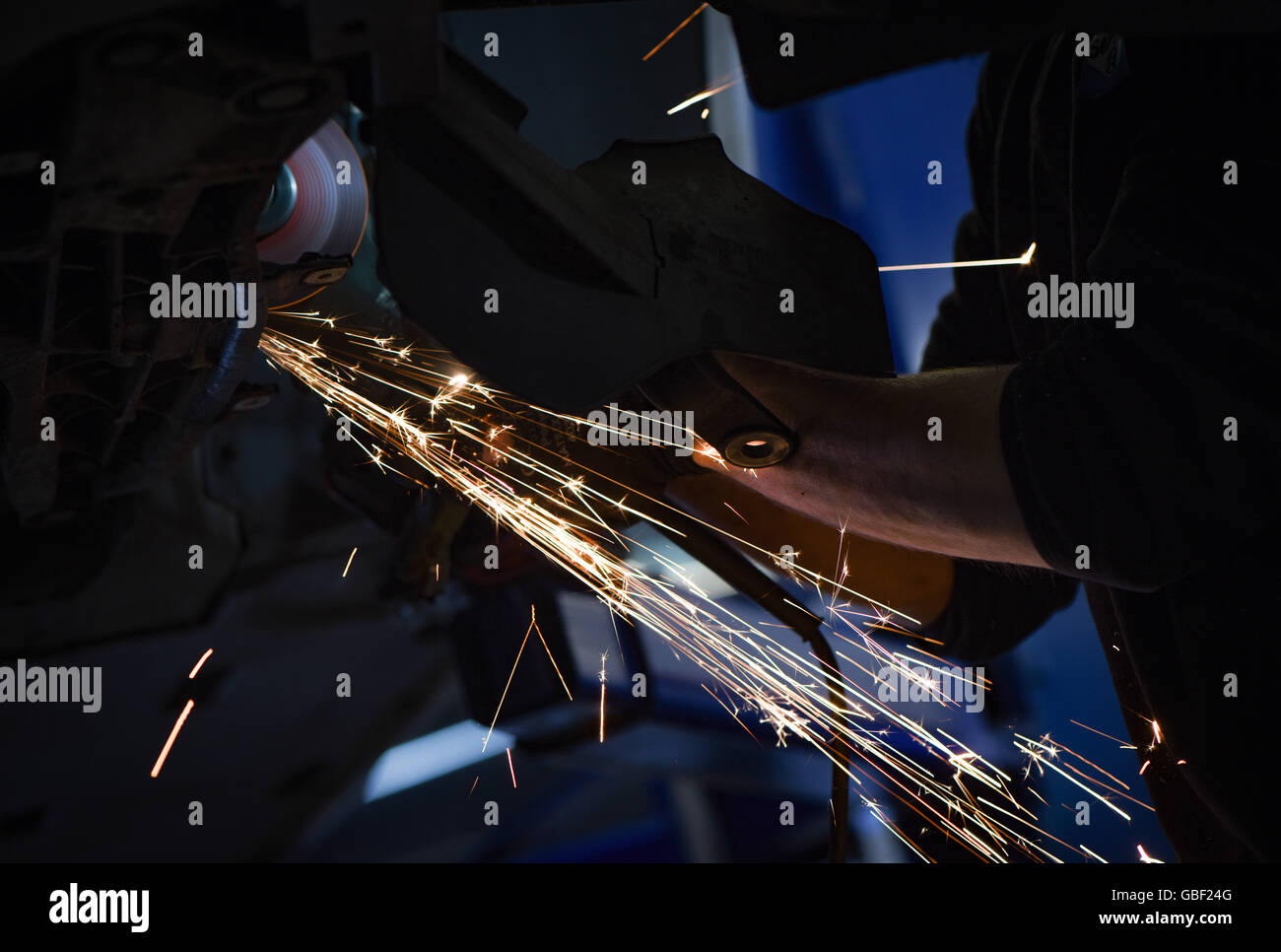 Mechanic working on car with cutter Stock Photo - Alamy