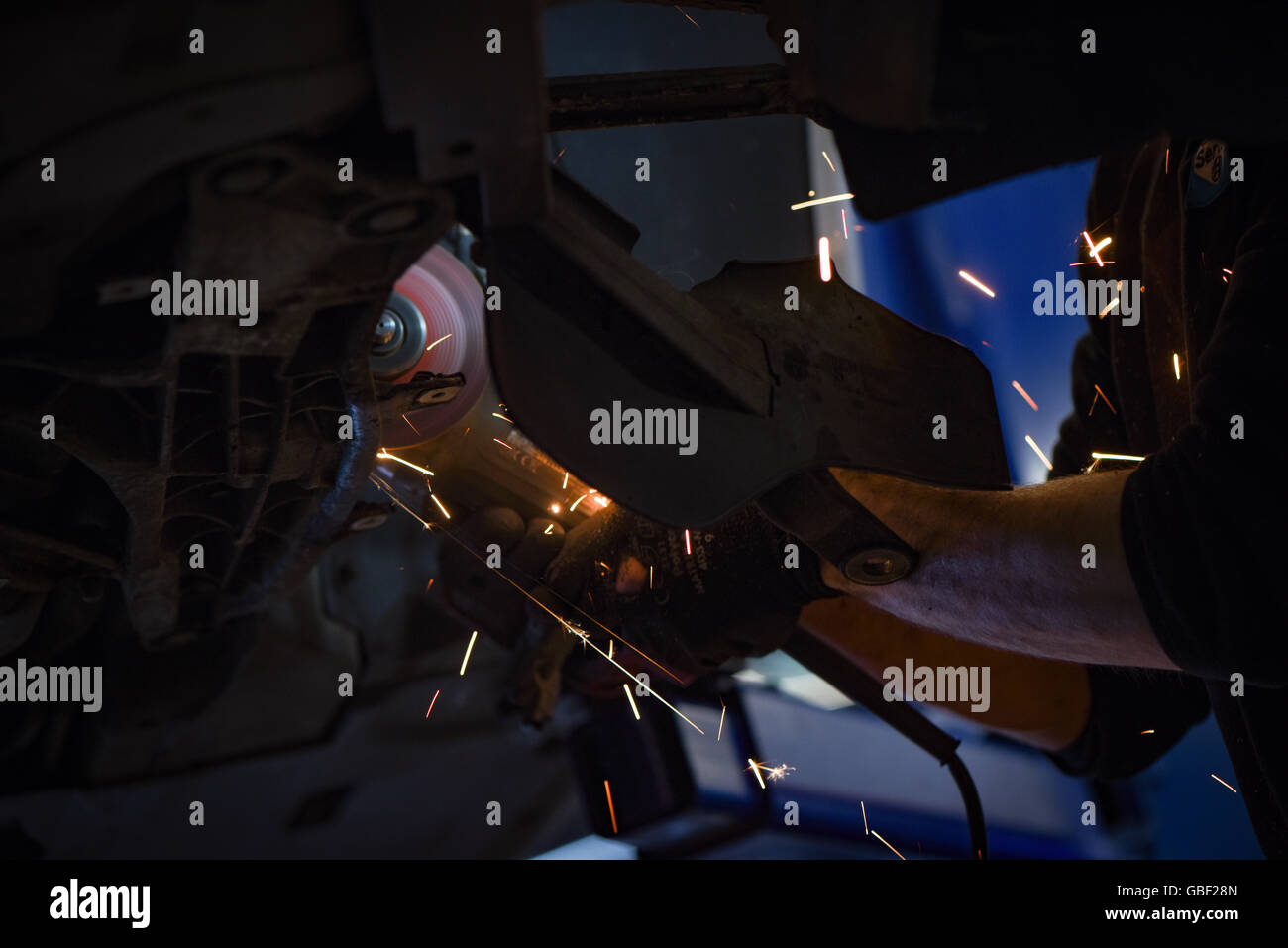 Mechanic working on car with cutter Stock Photo - Alamy