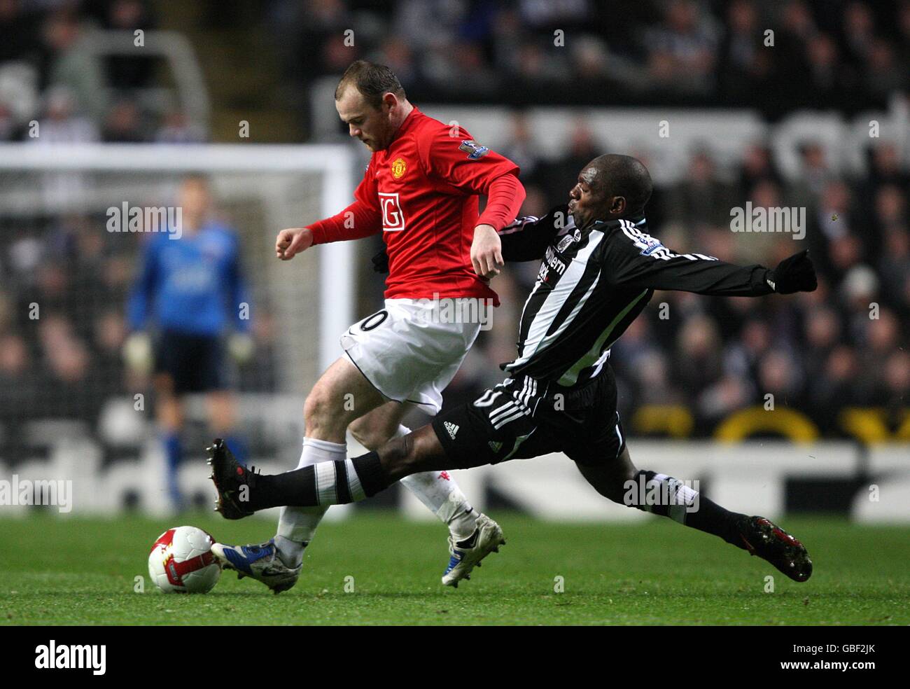 Manchester United's Wayne Rooney (left) and Newcastle United's Geremi ...