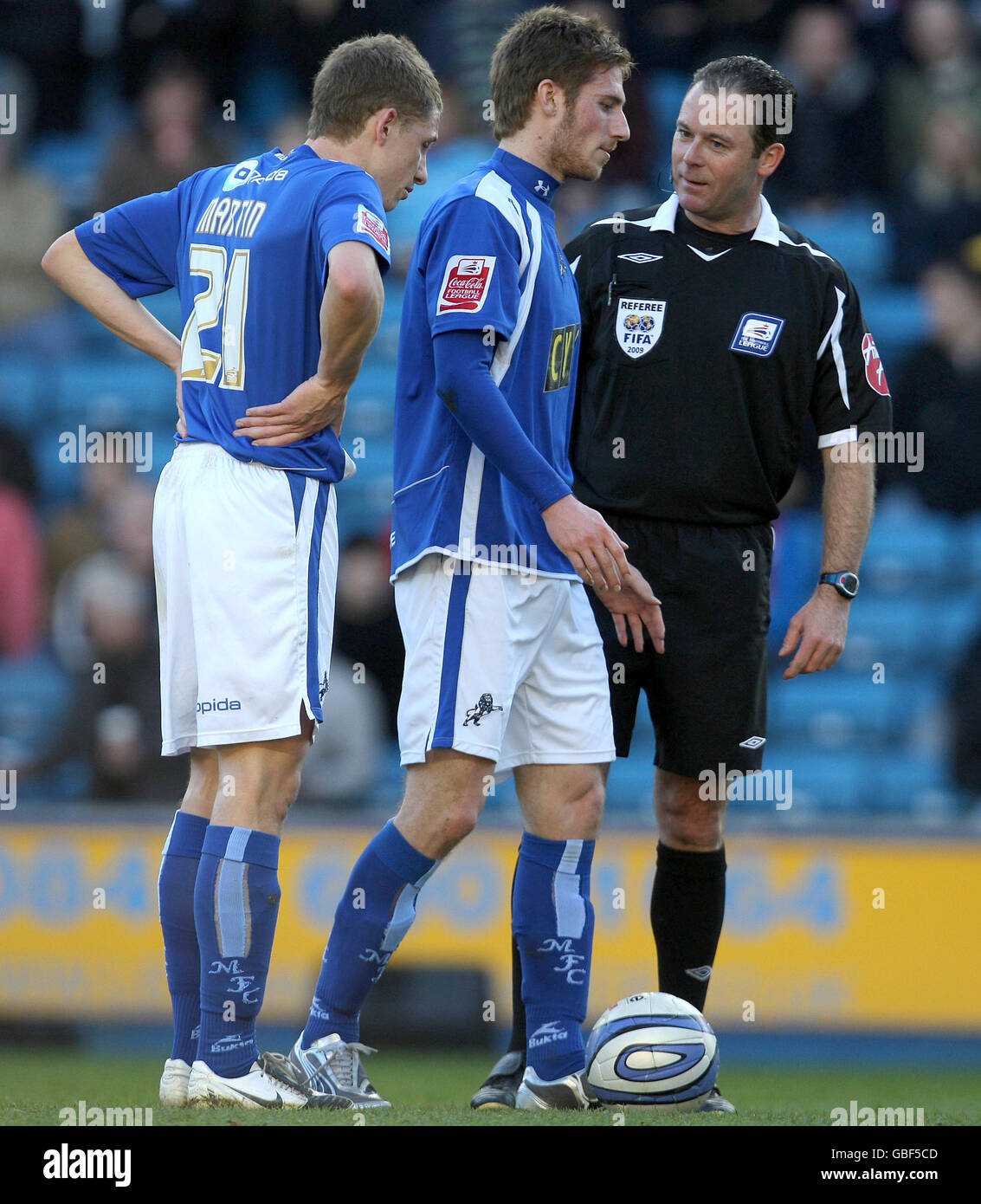 Referee Rob Styles with Millwall's James Henry (centre) and David ...