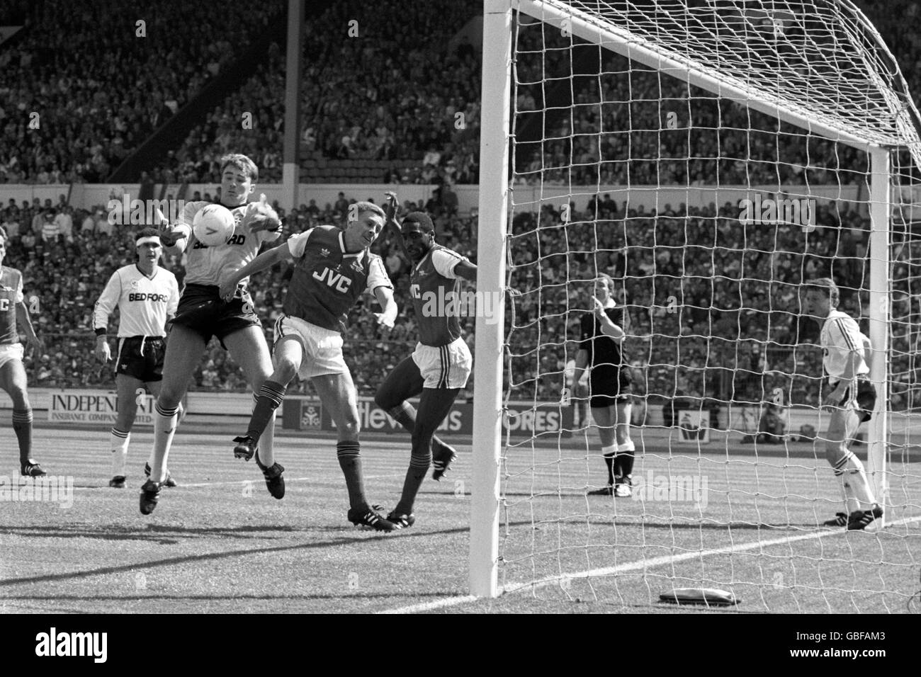 Andy Dibble just catches the ball as Kevin Richardson (centre) and Gus ...