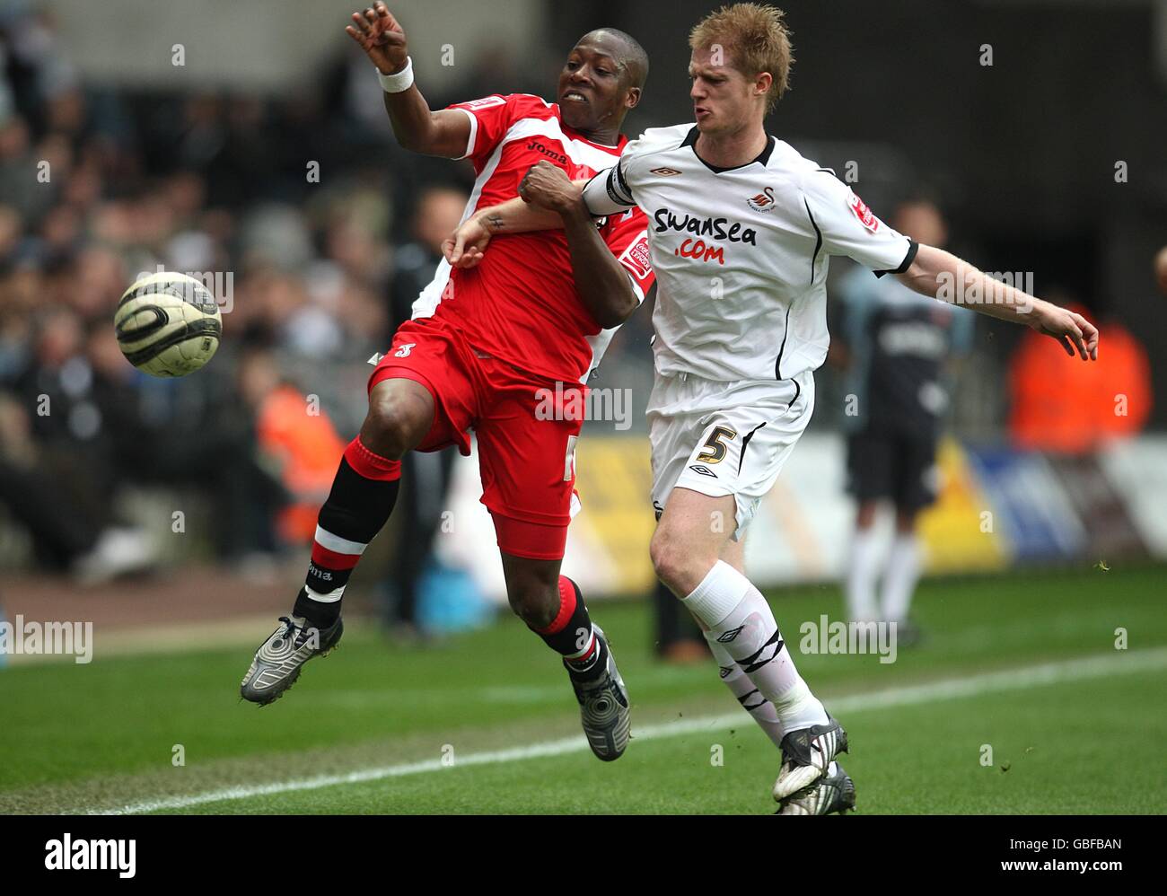 Charlton Athletic's Chris Dickson (left) and Swansea City's Alan Tate ...