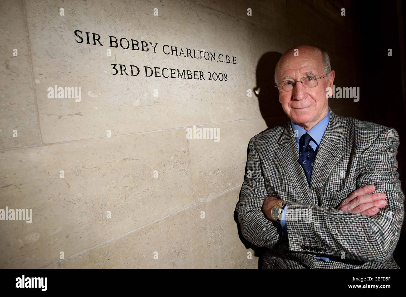 Sir Bobby Charlton stands by the wall bearing the names of people given ...