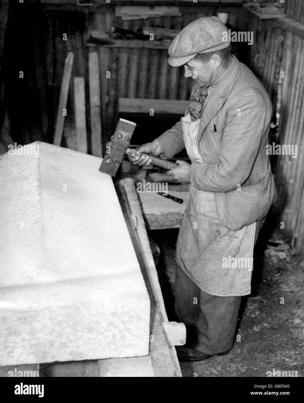 A stonemason dressing some of the granite for the continuation of the ...