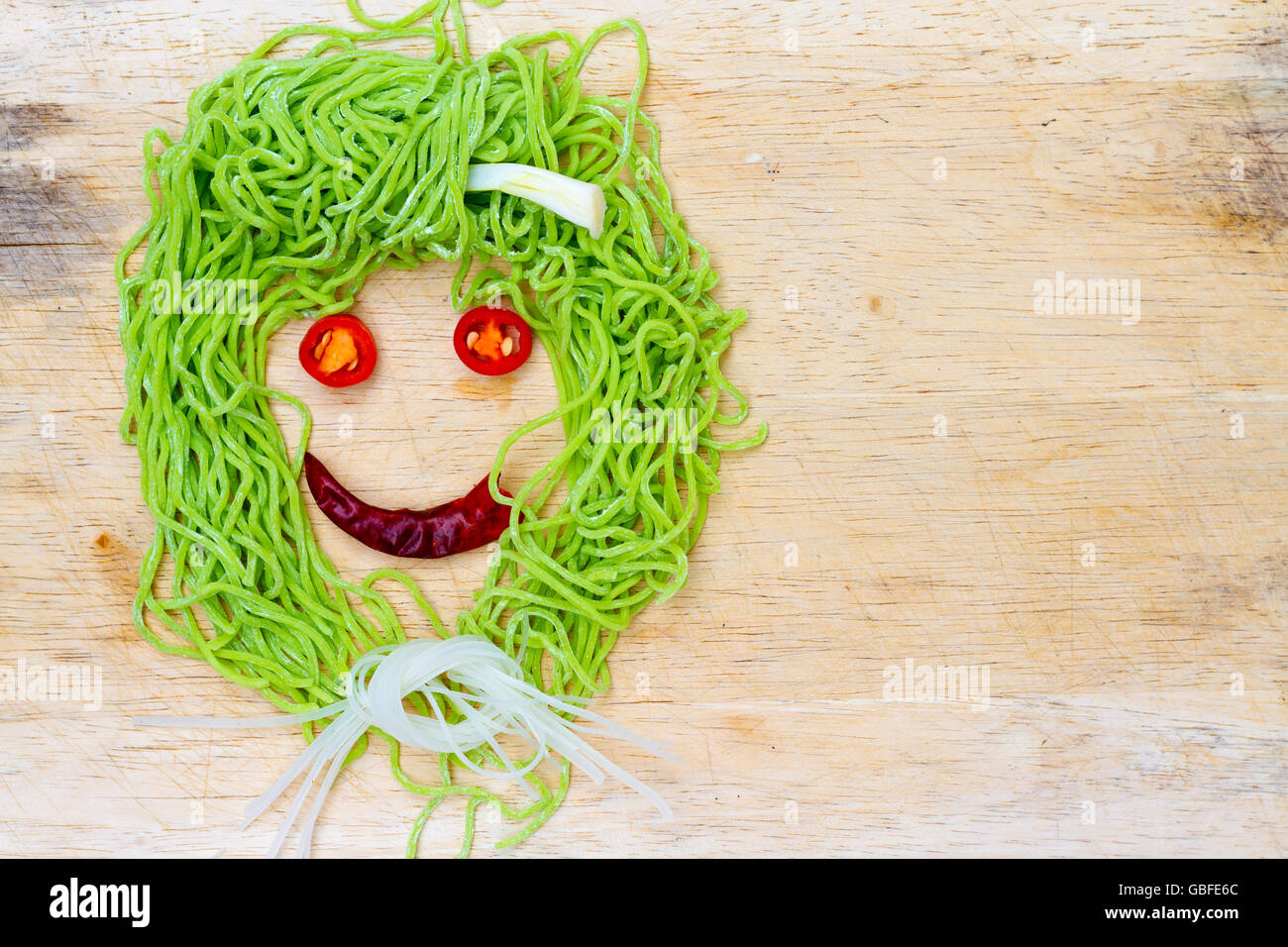 smile faces on wood background made from vegetable and noodle with ...