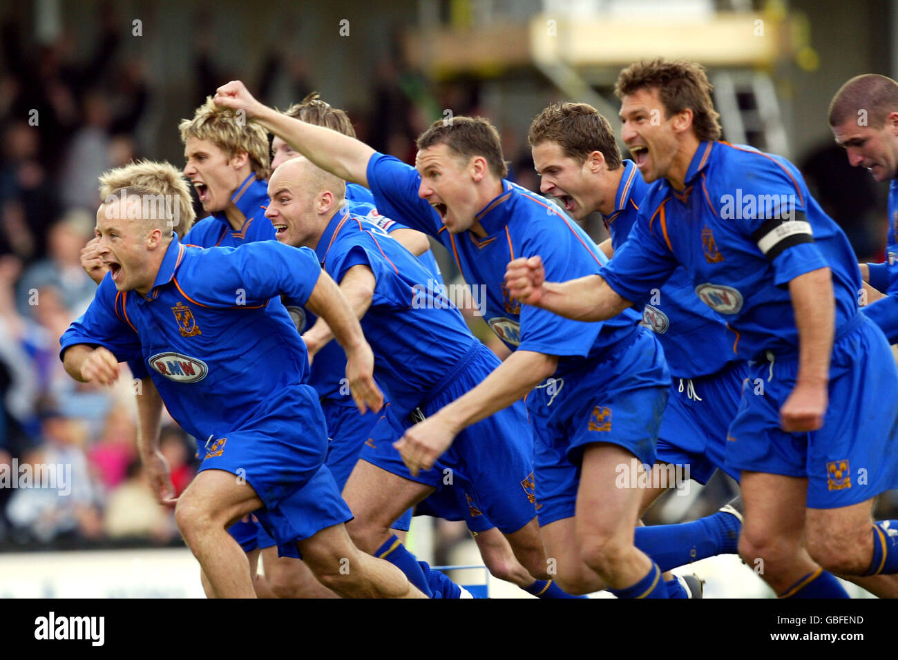 Shrewsbury Town players celebrate as Scott Howie saves the penalty that ...