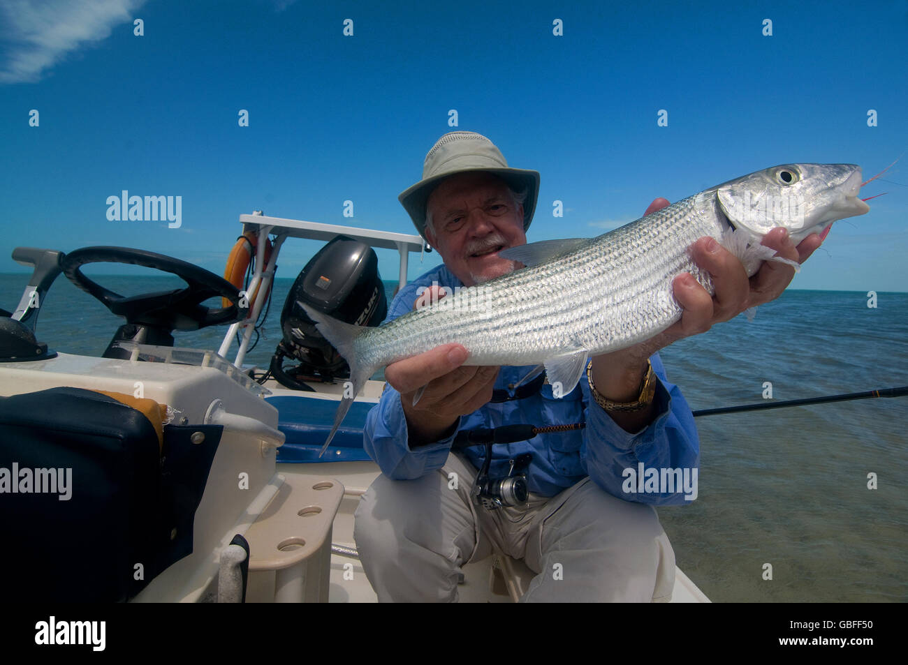 An angler lifts a large bonefish prior to release in the Turks & Caicos ...