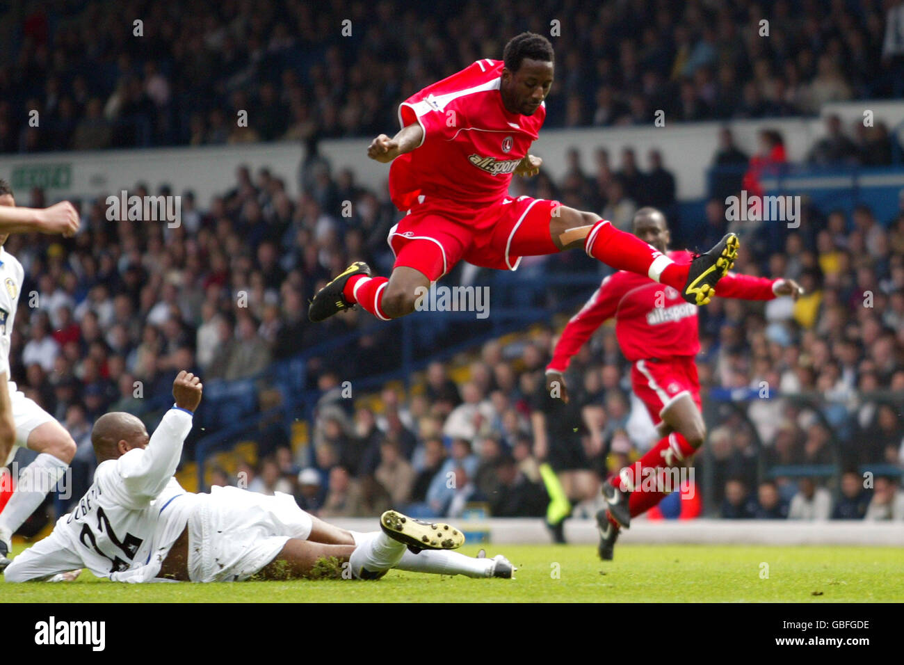 Charlton Athletic's Jason Euell (r) leaps to avoid a sliding tackle ...