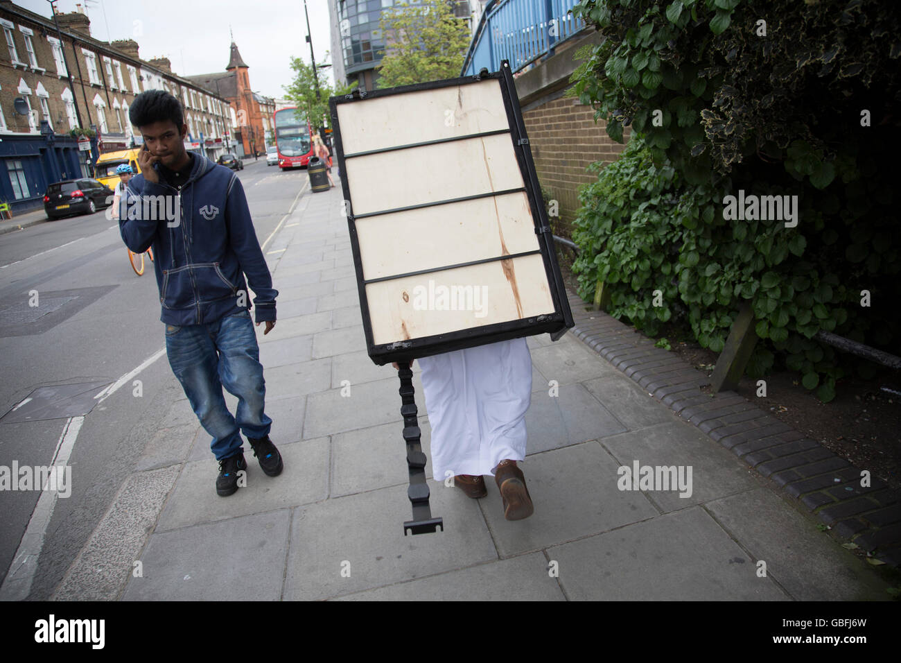 Man carrying a piece of furniture hi-res stock photography and images ...