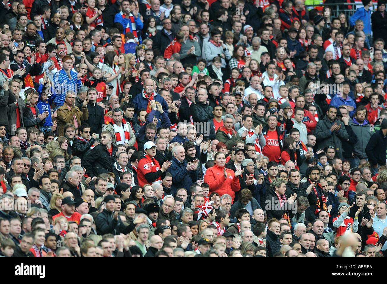 Manchester United fans cheer on their side in the stands Stock Photo ...