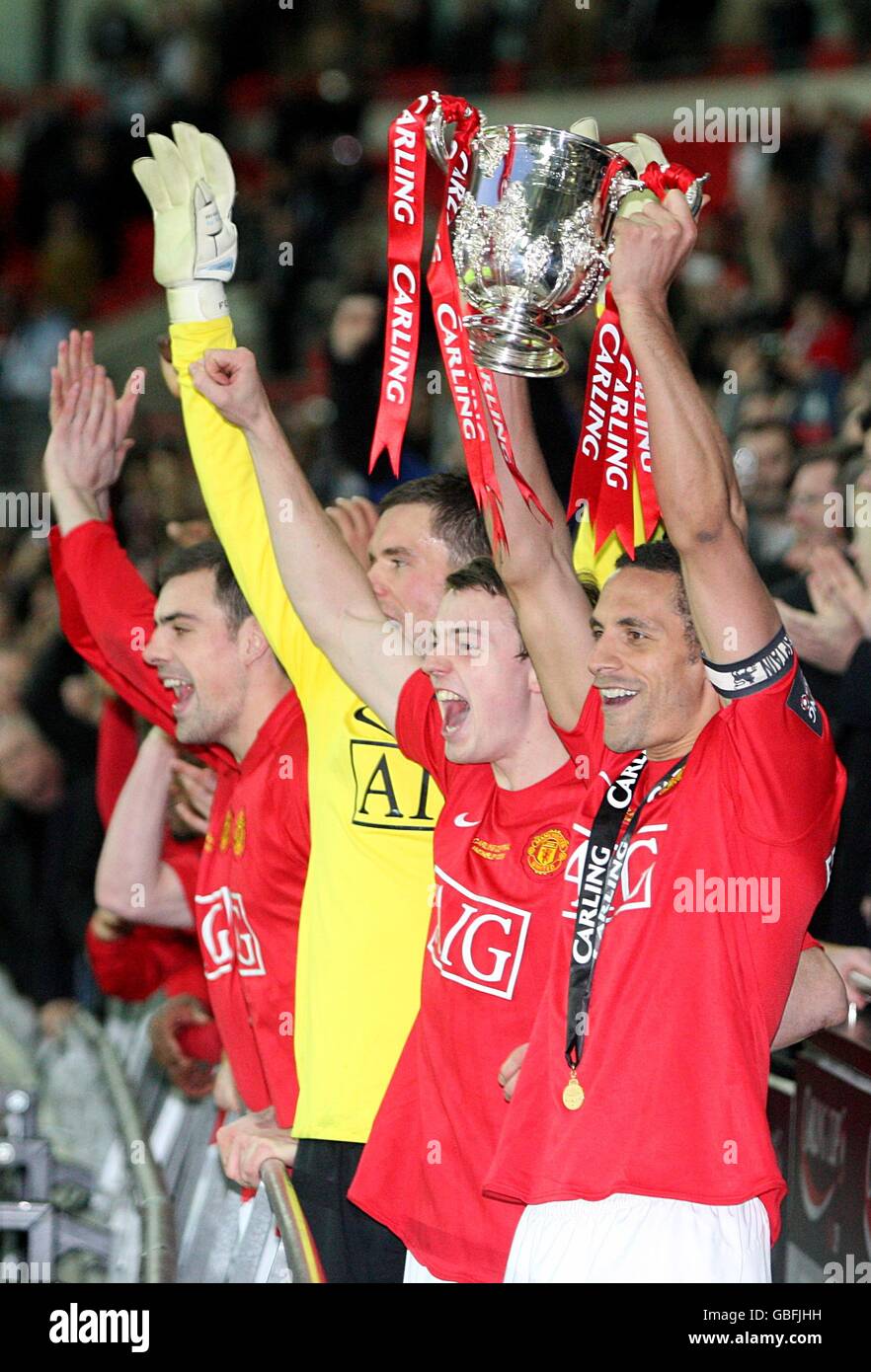 Manchester united captain rio ferdinand lifts the carling cup trophy hi ...