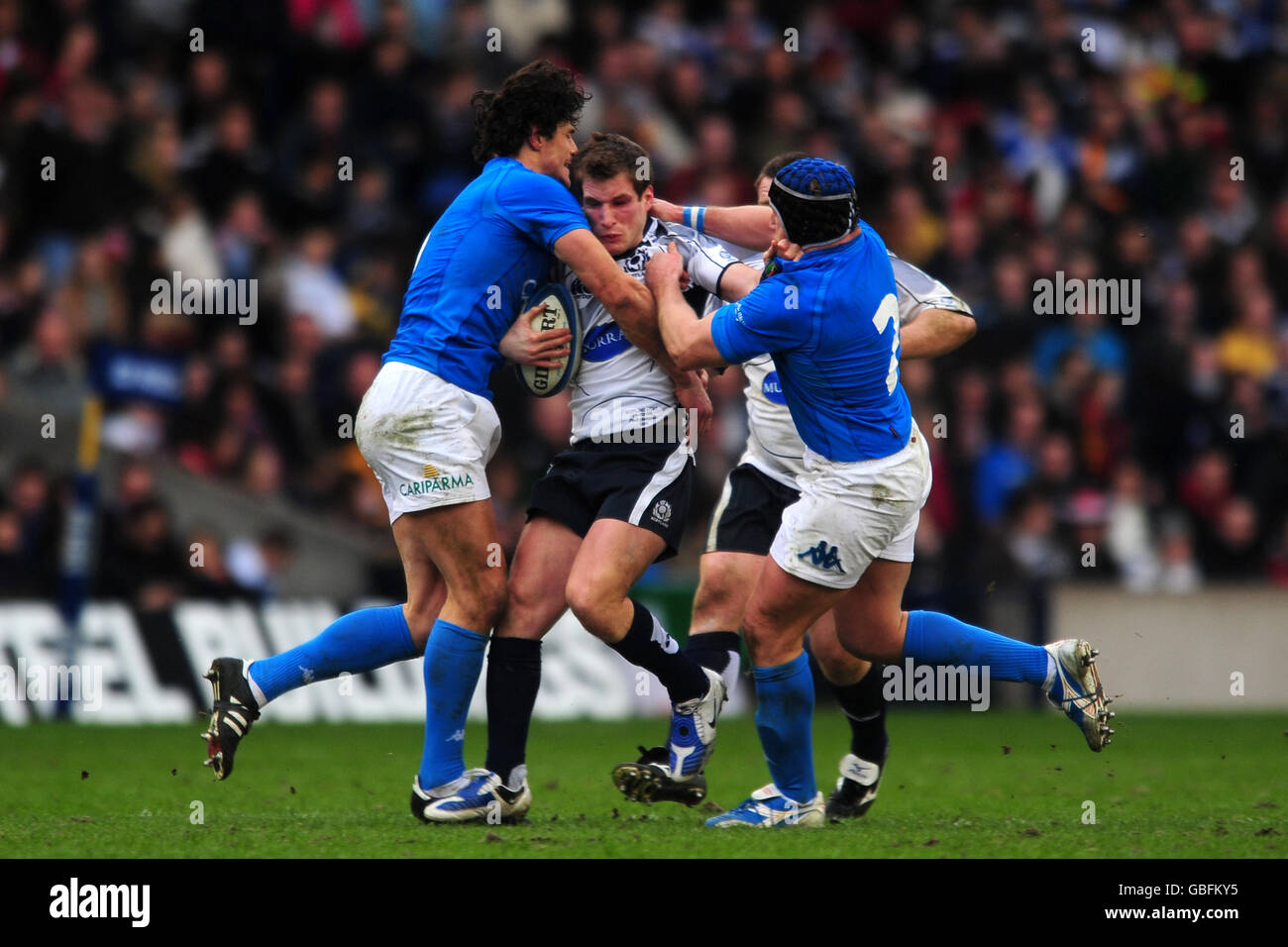 Scotland's Phil Godman (center) is tackled by Italy's Leonardo ...