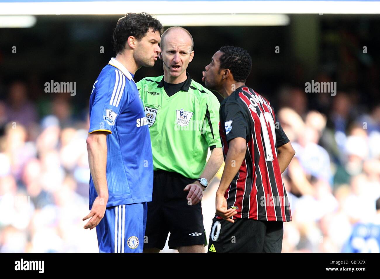Referee Mike Riley (centre) attempts to calm an argument between ...