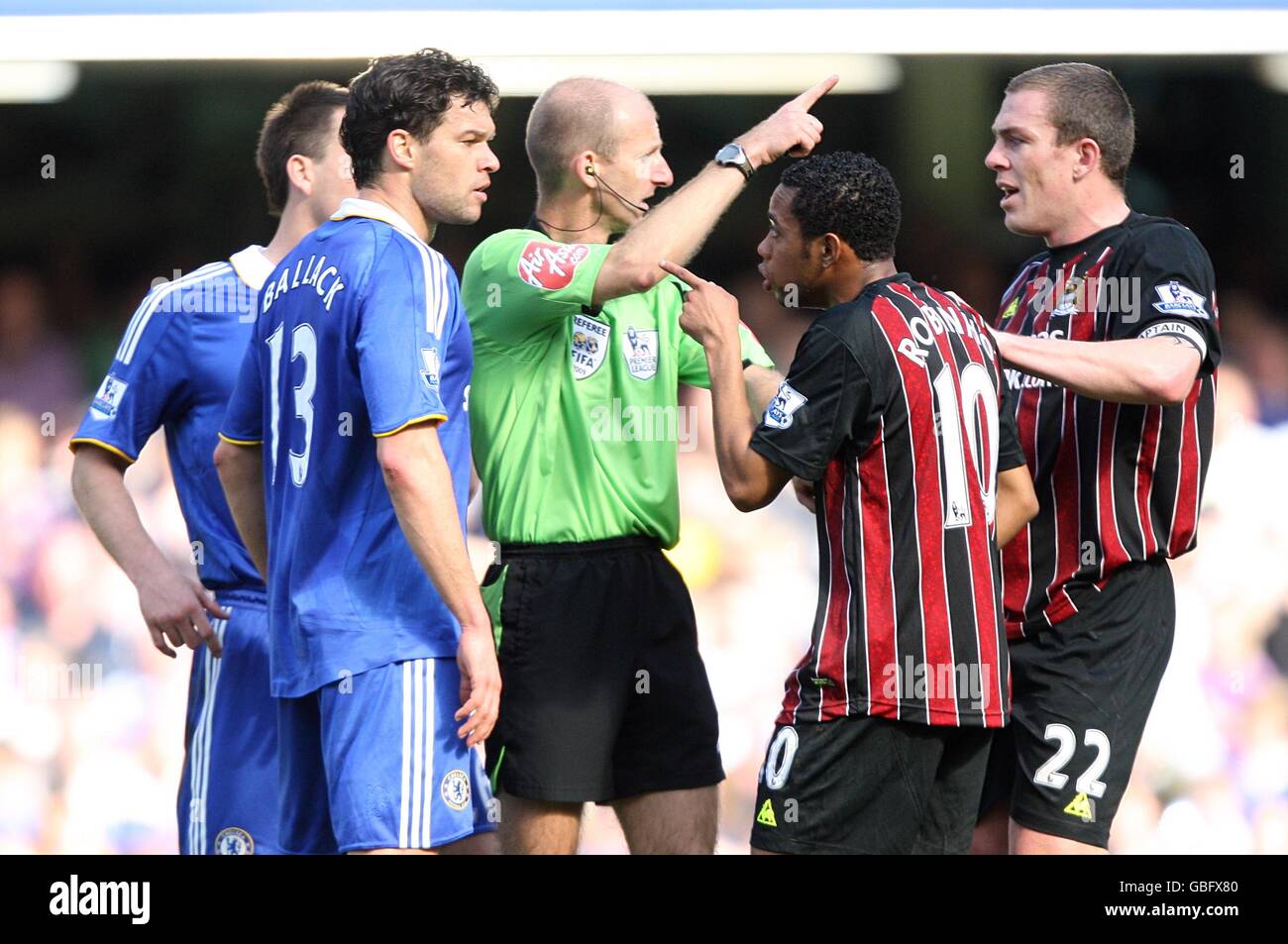 Referee Mike Riley (centre) attempts to calm an argument between ...