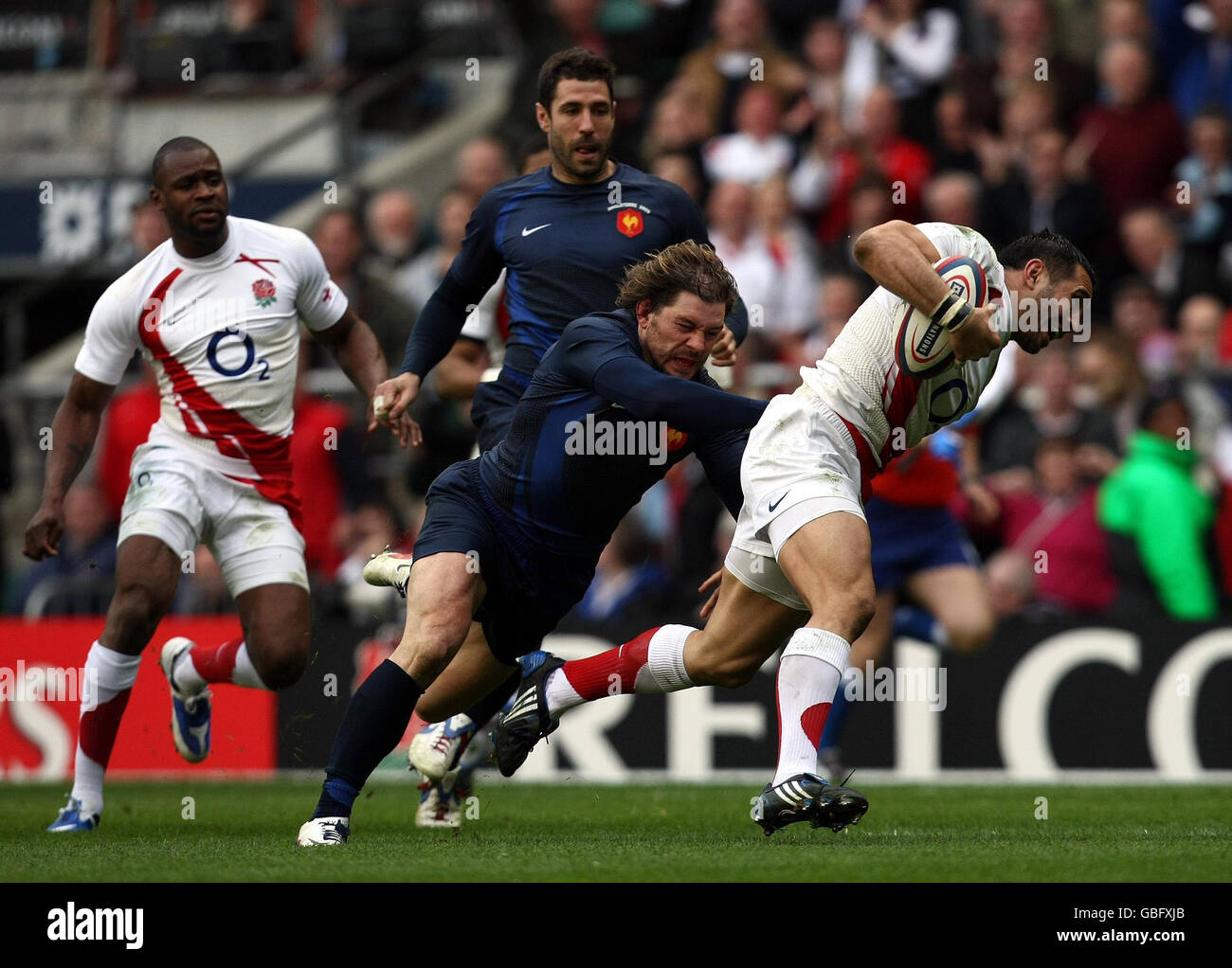 France's Cedric Heymans (centre) attempts to tackle England's Riki ...