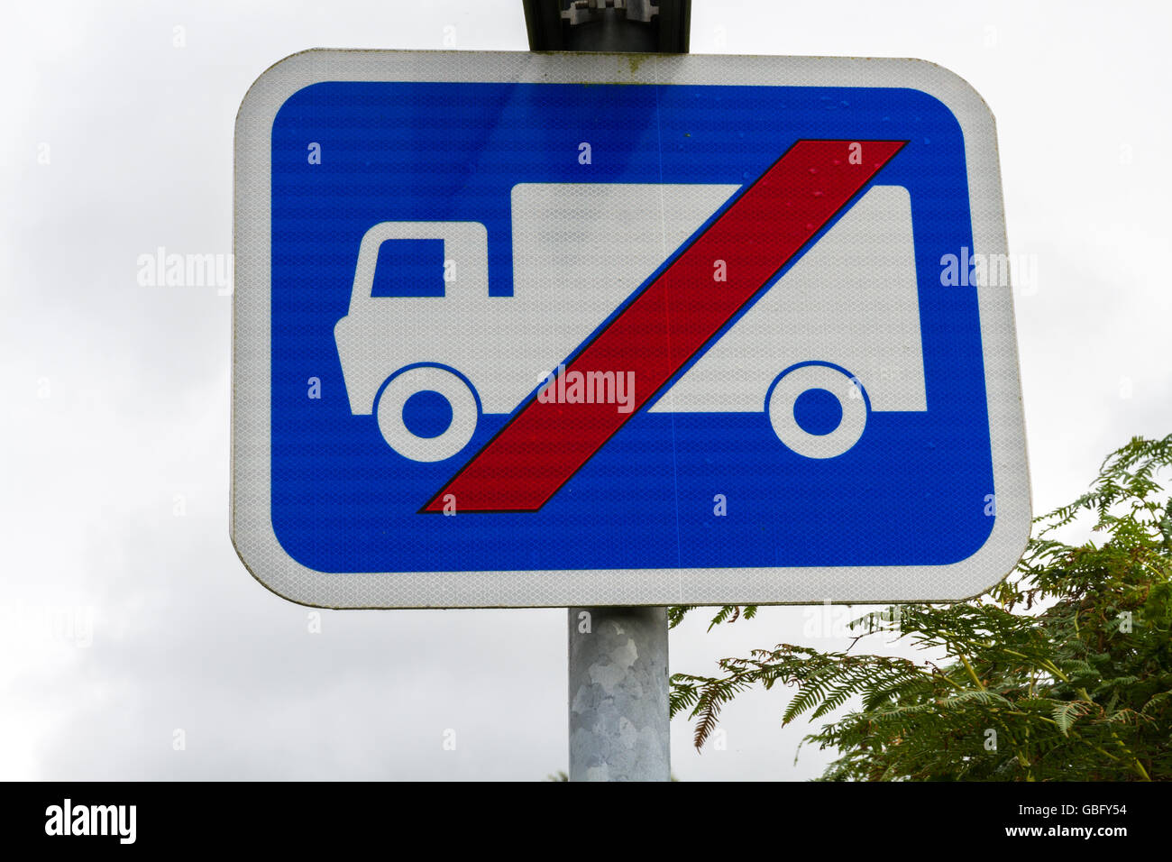 Blue sign showing lorry or HGV with red line through it to warn that ...