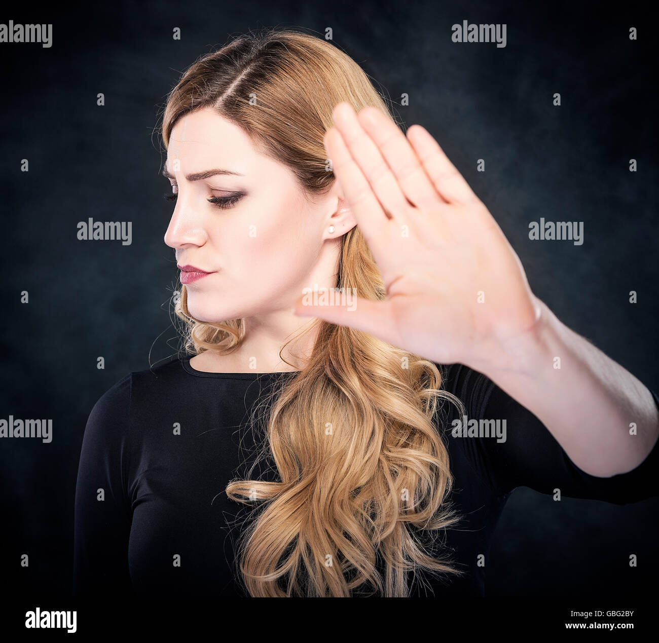 Woman shows stop sign on dark background Stock Photo - Alamy Woman shows stop sign on dark background Stock Photo - Alamy