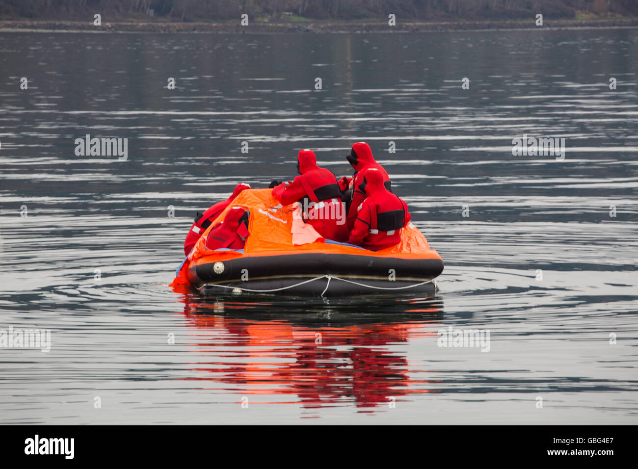 Sailors in a life raft Stock Photo - Alamy