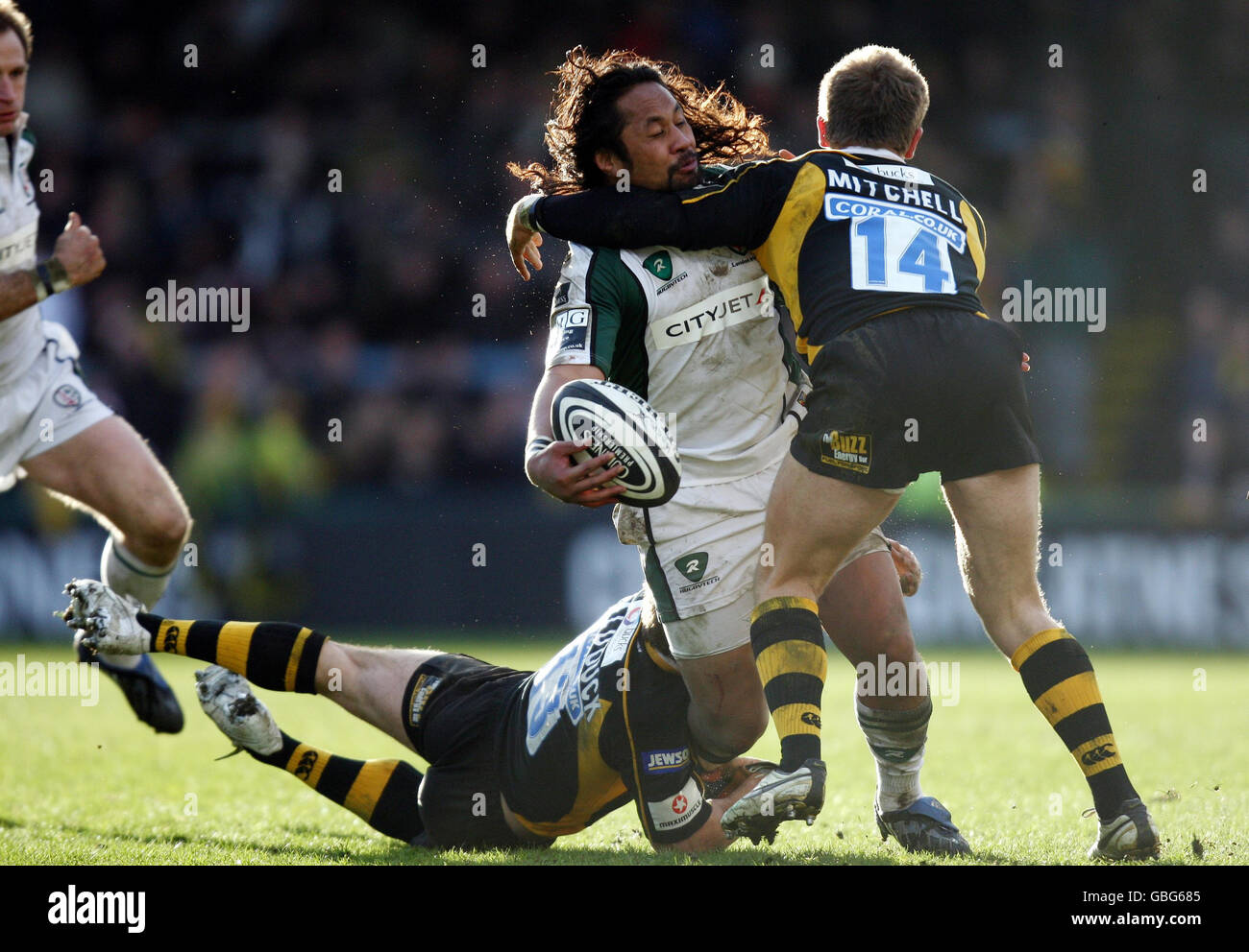 London Irish's Seilala Mapusua gets his pass away as he is tackled by ...
