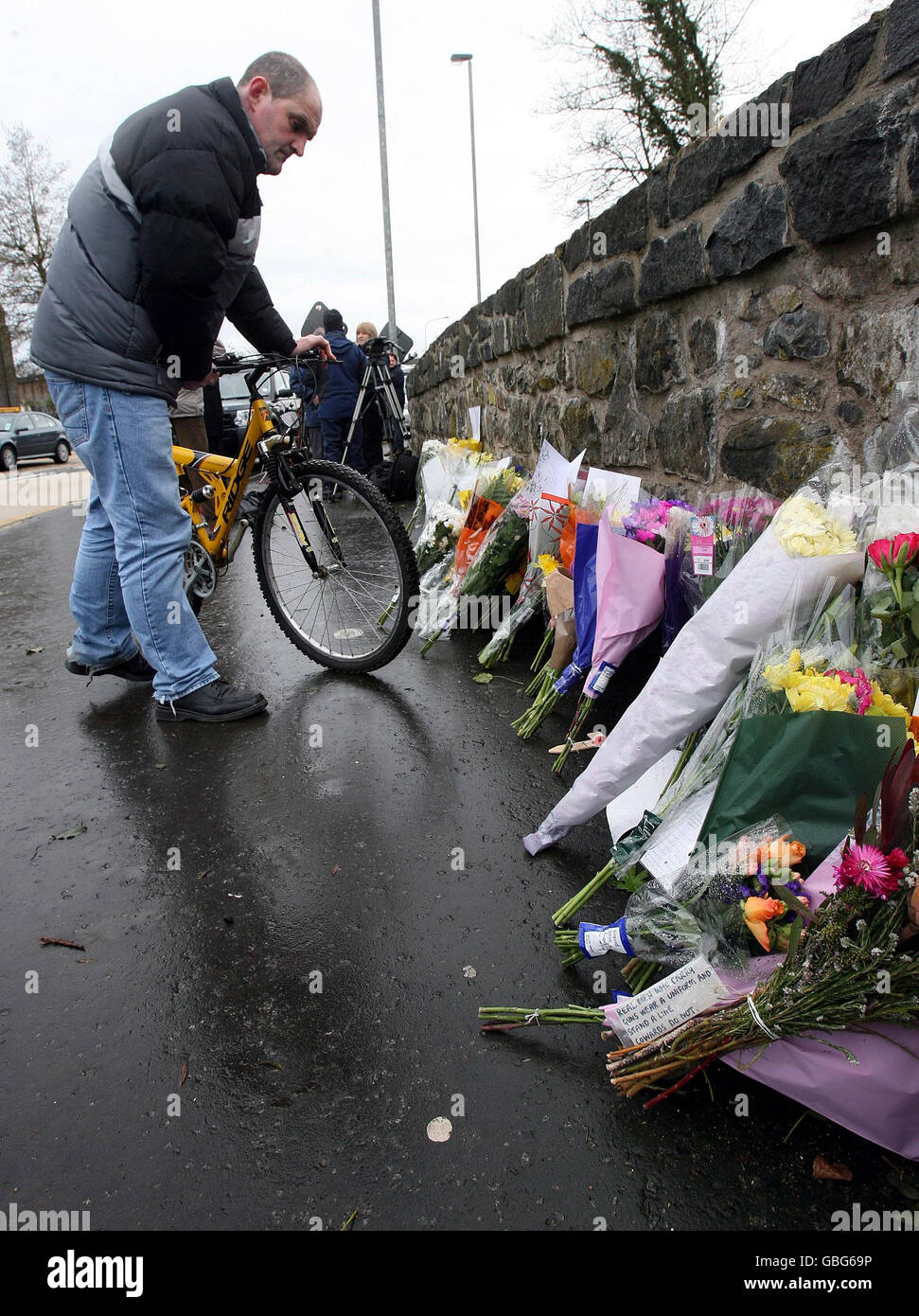 Flowers left at the scene of a shooting at Massereene Barracks in ...