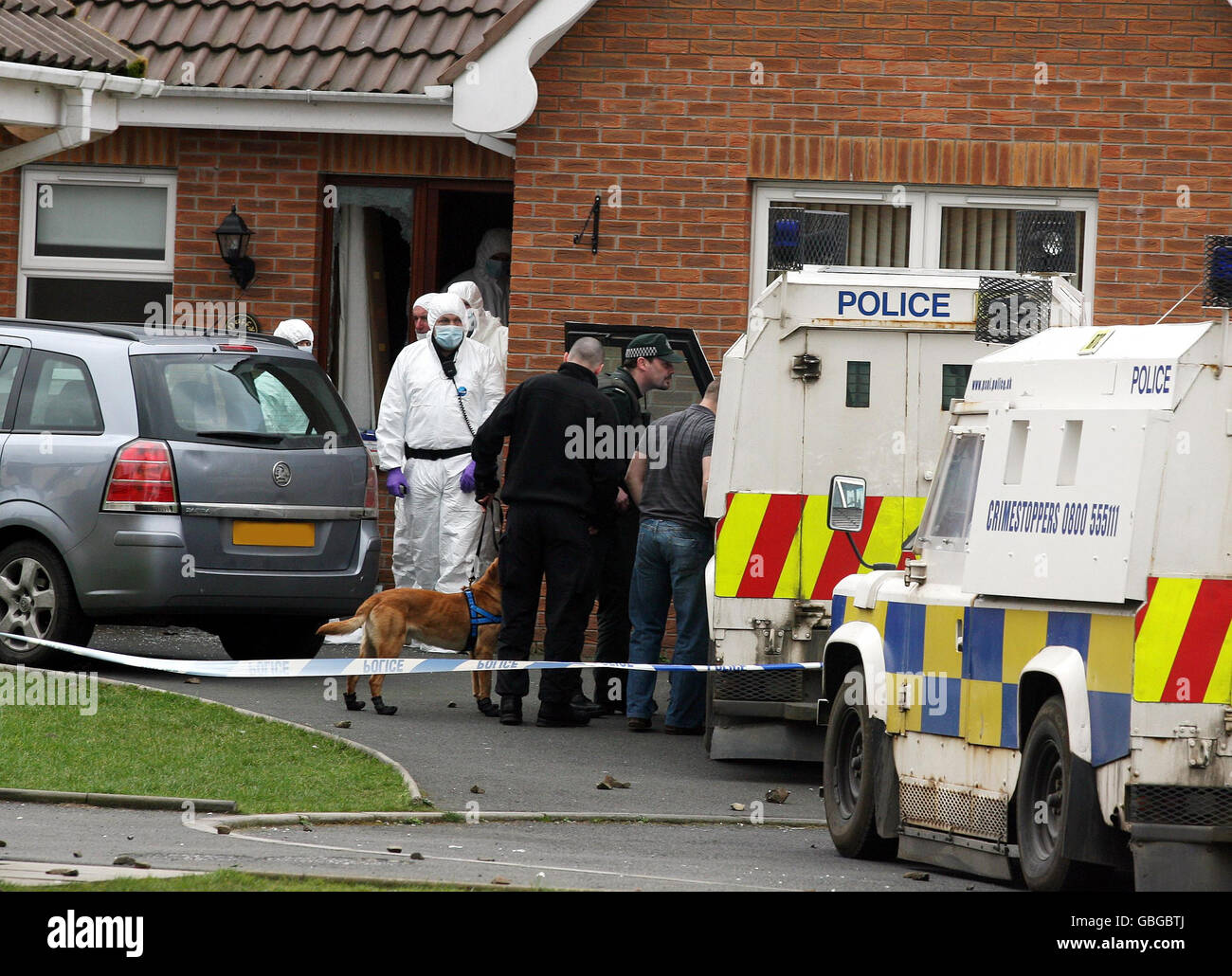 Forensic police officers outside the house of Colin Duffy, in Lurgan ...