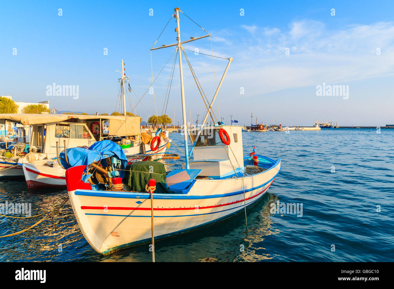 Traditional colourful Greek fishing boat in Pythagorion port at sunset ...