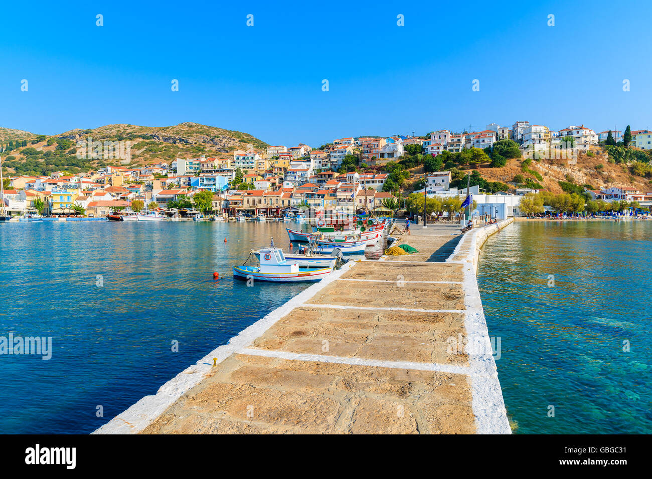 Pier in Pythagorion port with fishing boats in distance, Samos island ...