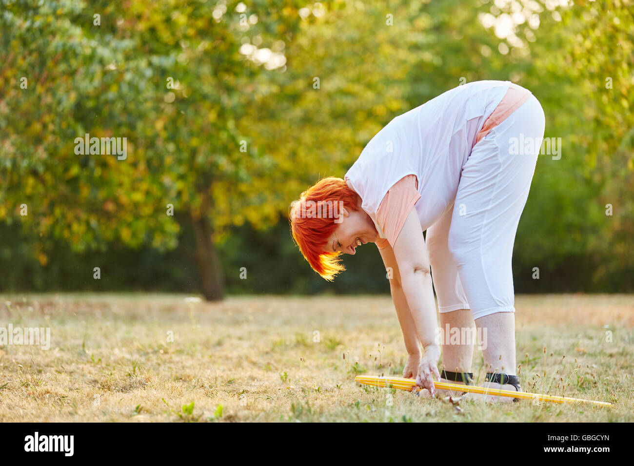 Active senior woman doing gymnastics with a hoop in summer Stock Photo ...