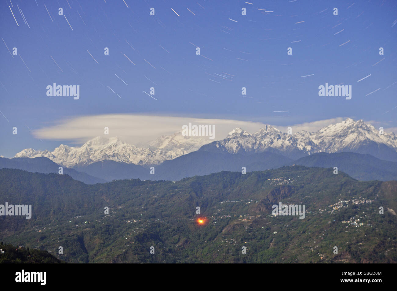 Kanchanjunga range glowing in moonlight along with star trails, Sikkim ...