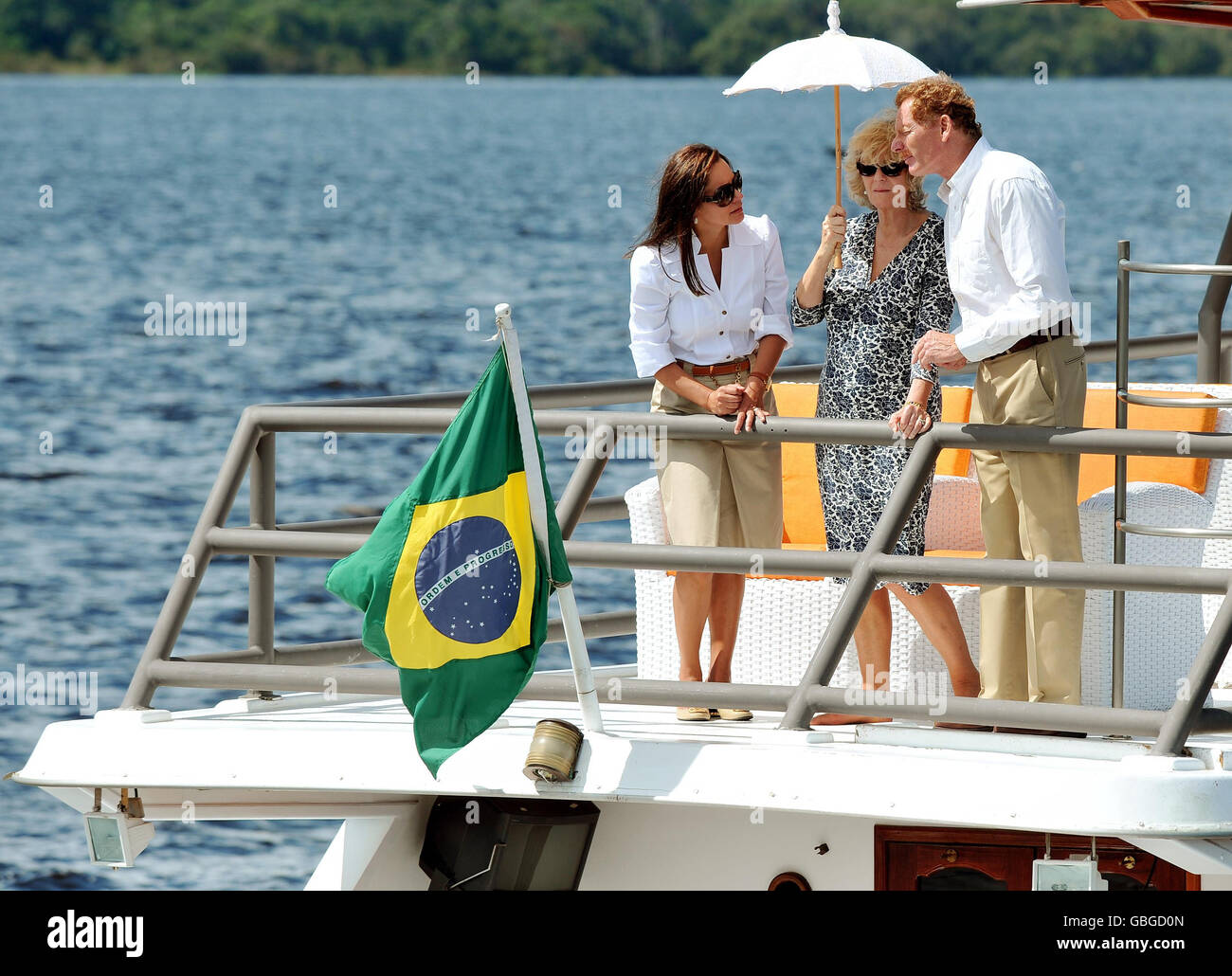 The Duchess of Cornwall stands under her parasol with Mrs Sandra Braga ...