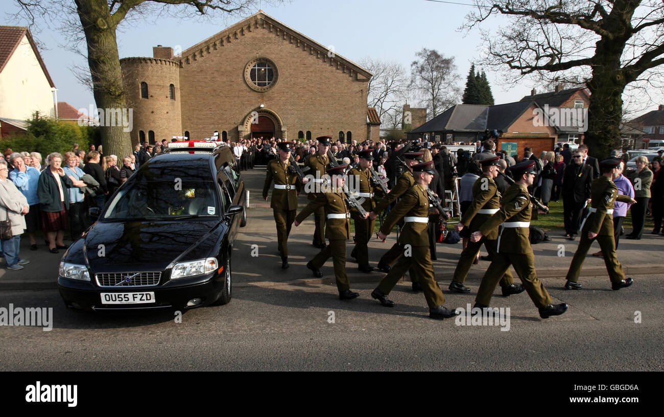 The guard of honour march past the hearse carrying Sapper Mark Quinsey ...
