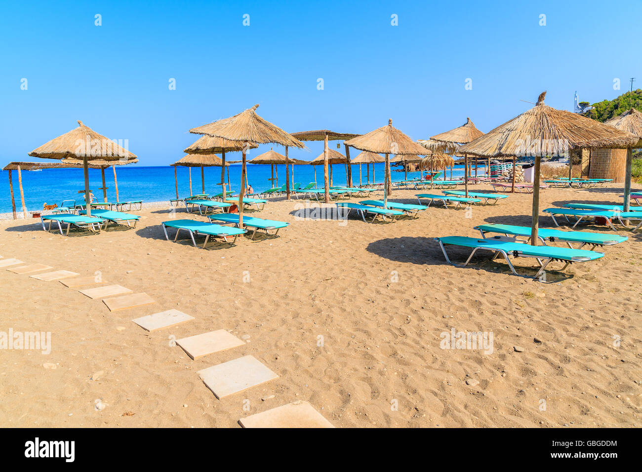 Umbrellas and sunbeds on sandy Potami beach, Samos island, Greece Stock ...