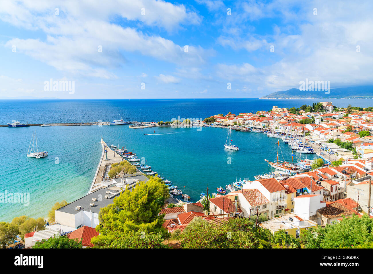 A view of Pythagorion port with colourful houses and blue sea, Samos ...